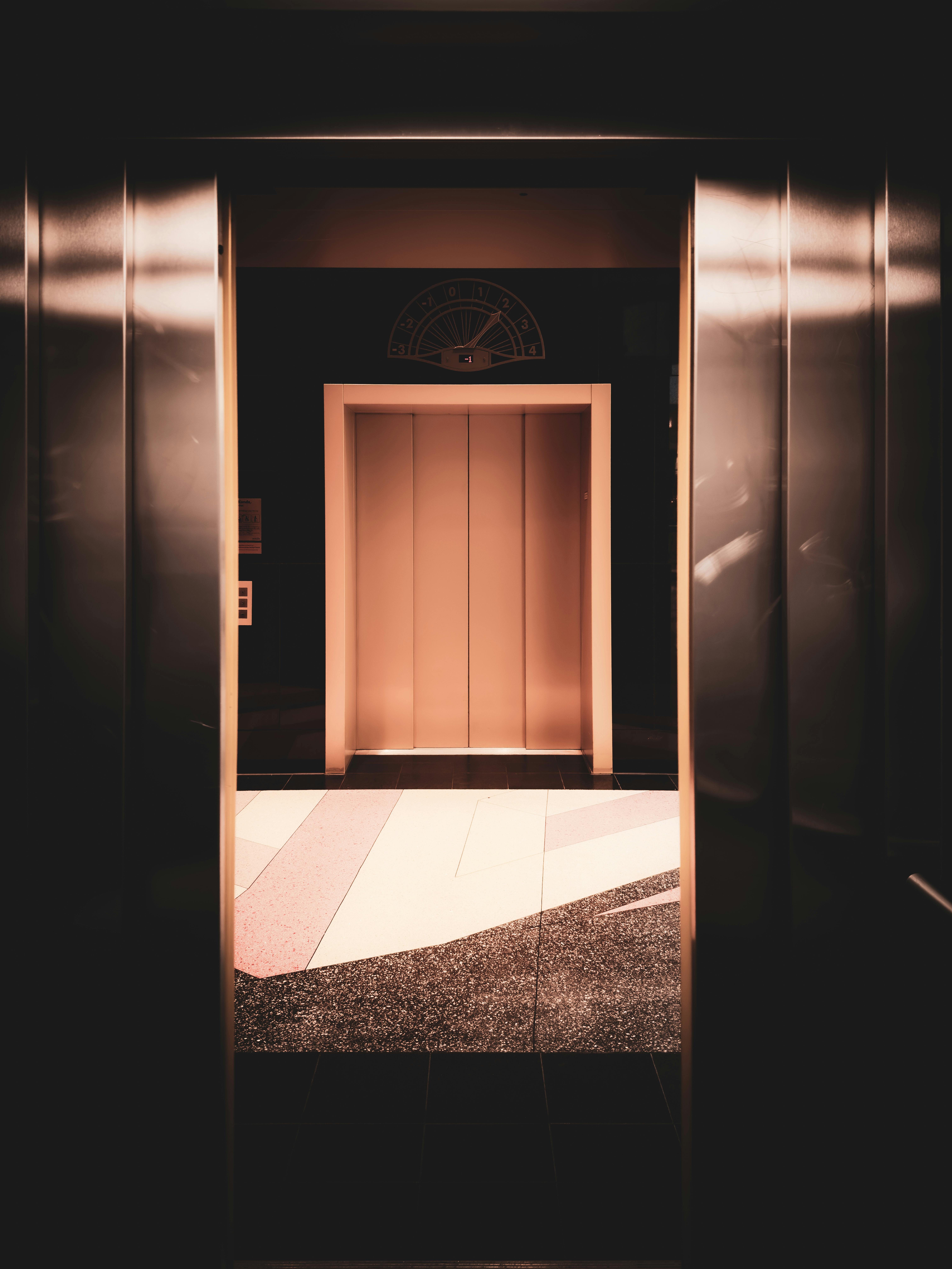 Modern Elevator Interior with Warm Lighting · Free Stock Photo