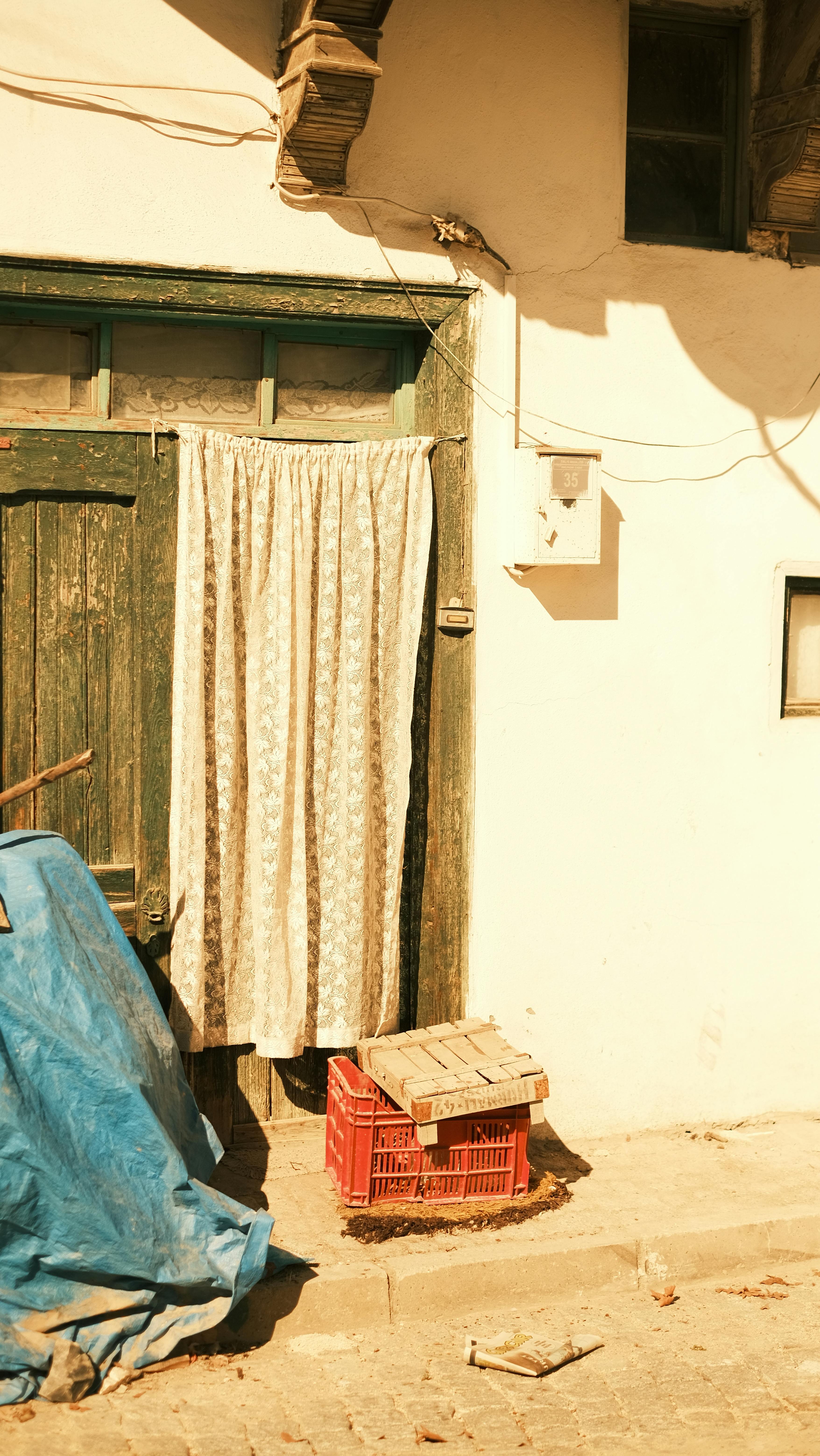 Rustic Courtyard with Wooden Doorway and Crate · Free Stock Photo