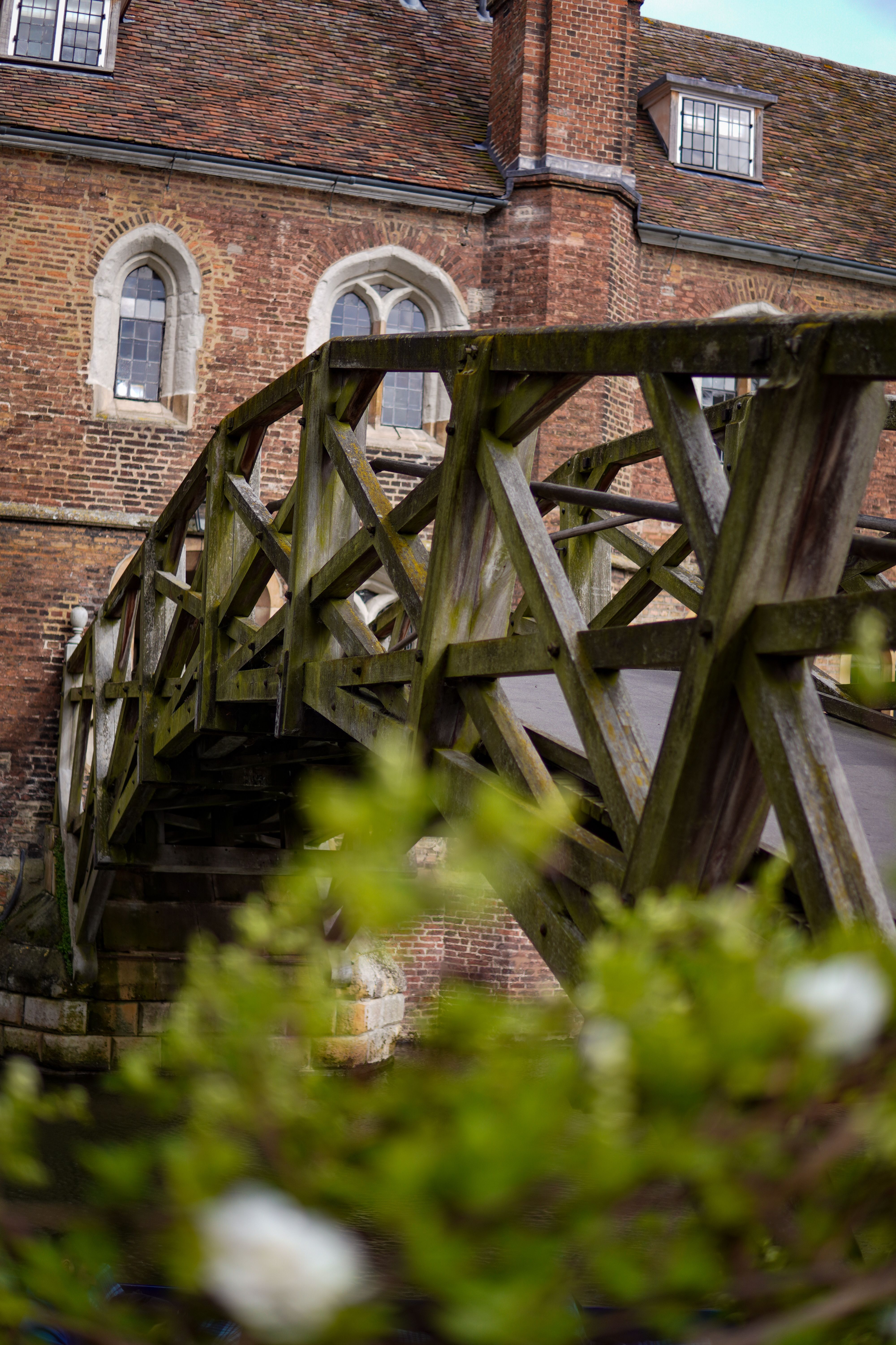 Historic Wooden Bridge Connecting Brick Building · Free Stock Photo