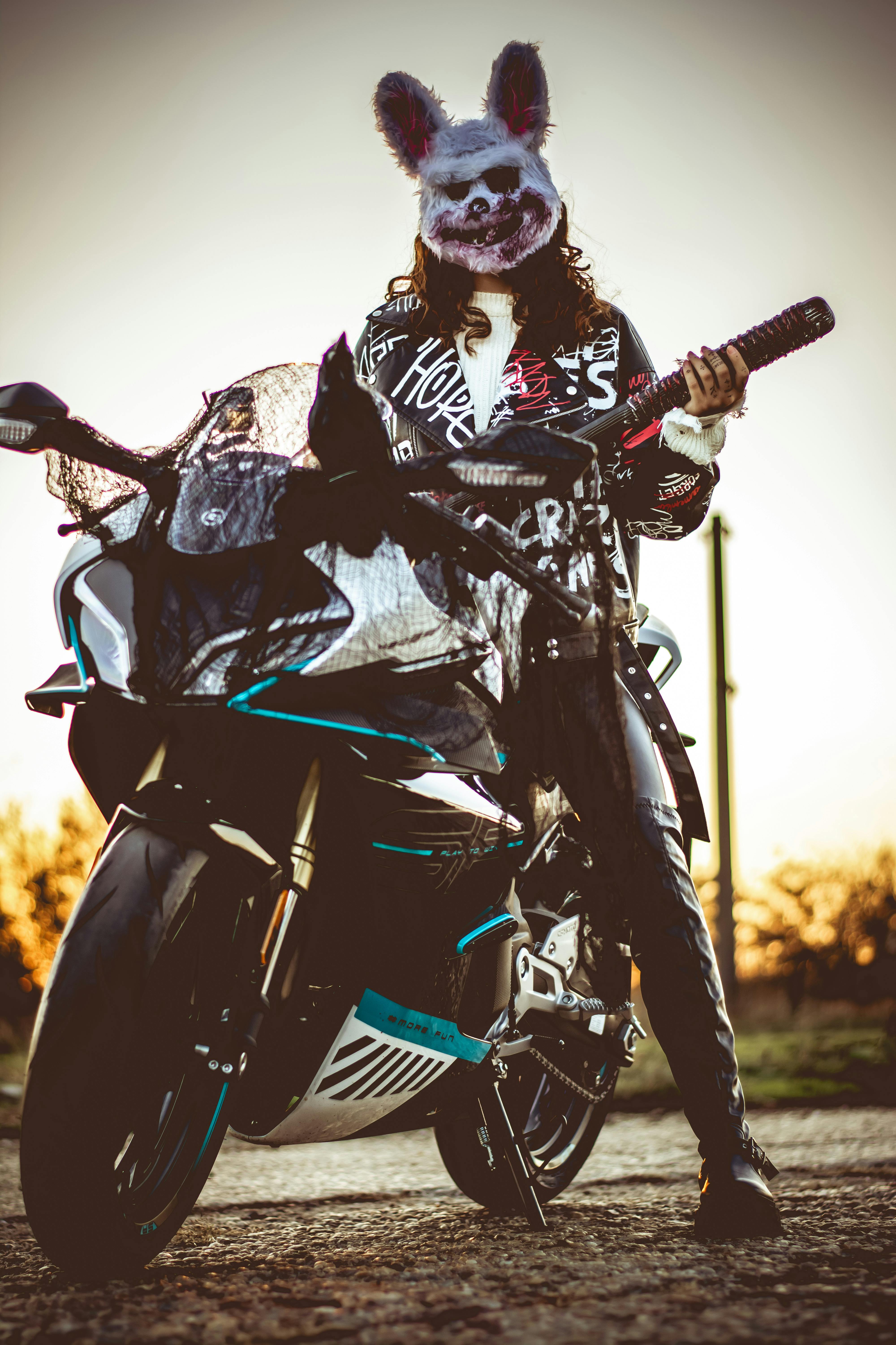 Edgy Biker in Mask Holding Sword and Motorcycle · Free Stock Photo