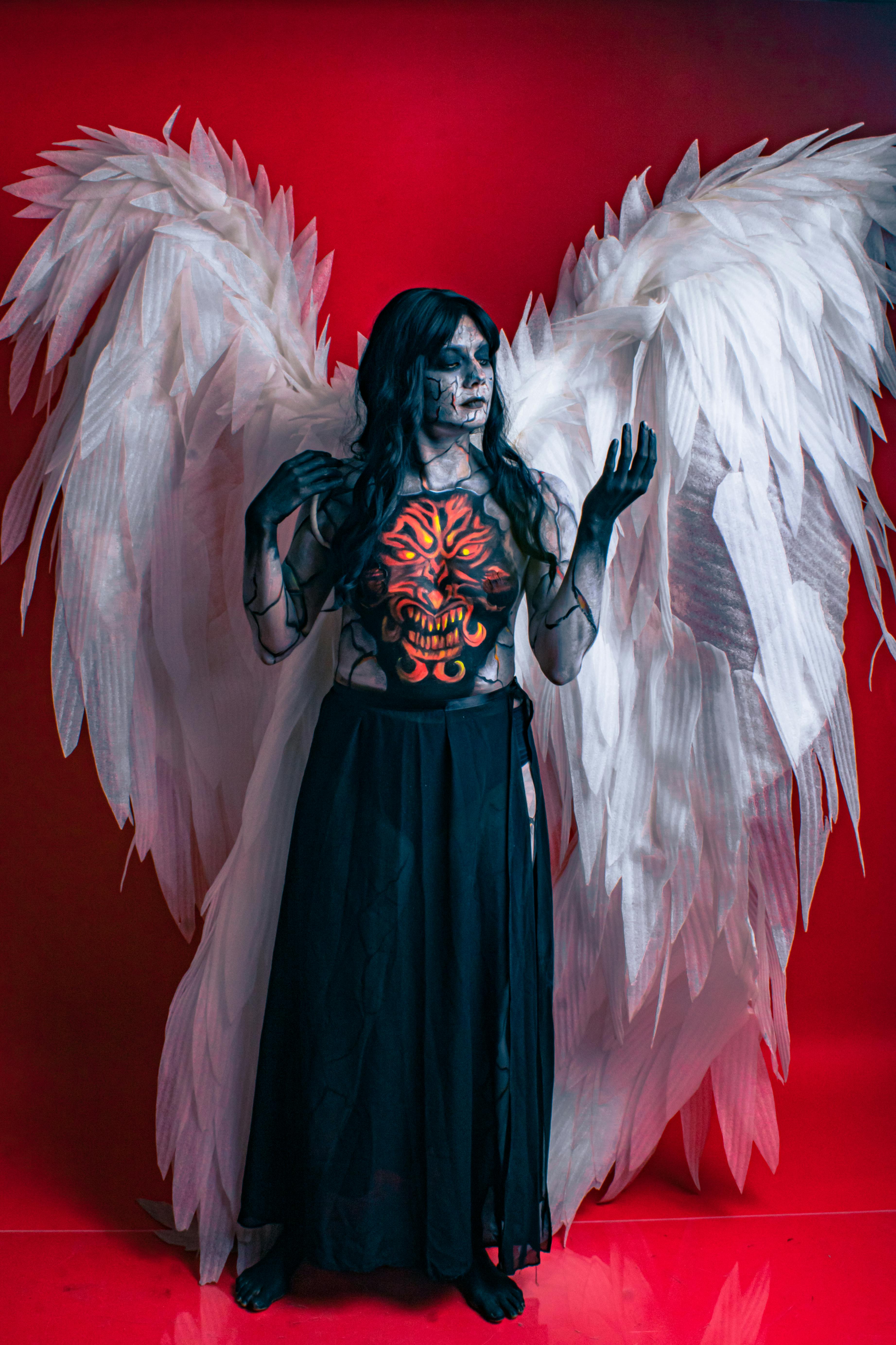 Dramatic Angelic Figure with Artistic Makeup and Wings · Free Stock Photo