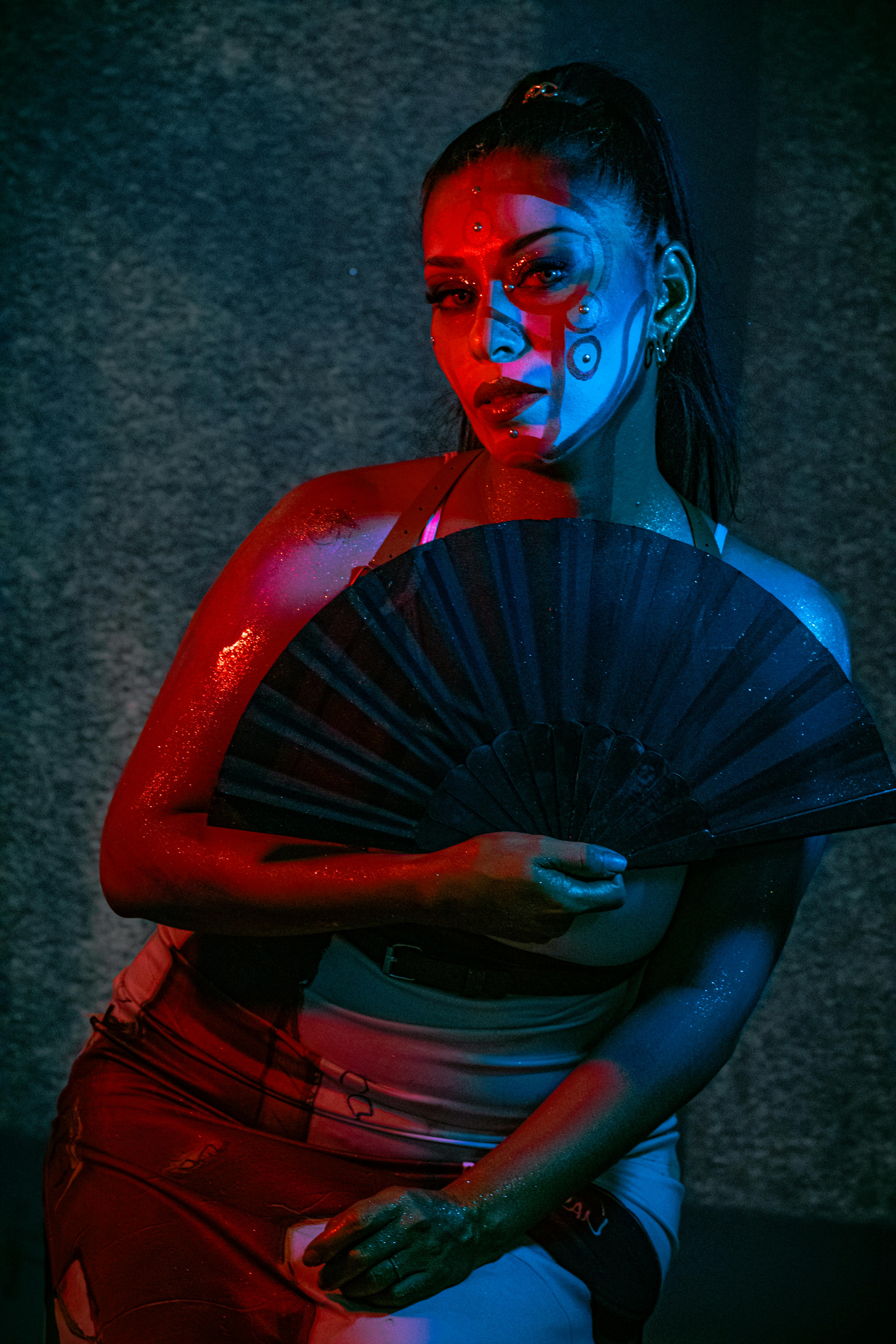 Striking Artistic Makeup Portrait with Fan · Free Stock Photo