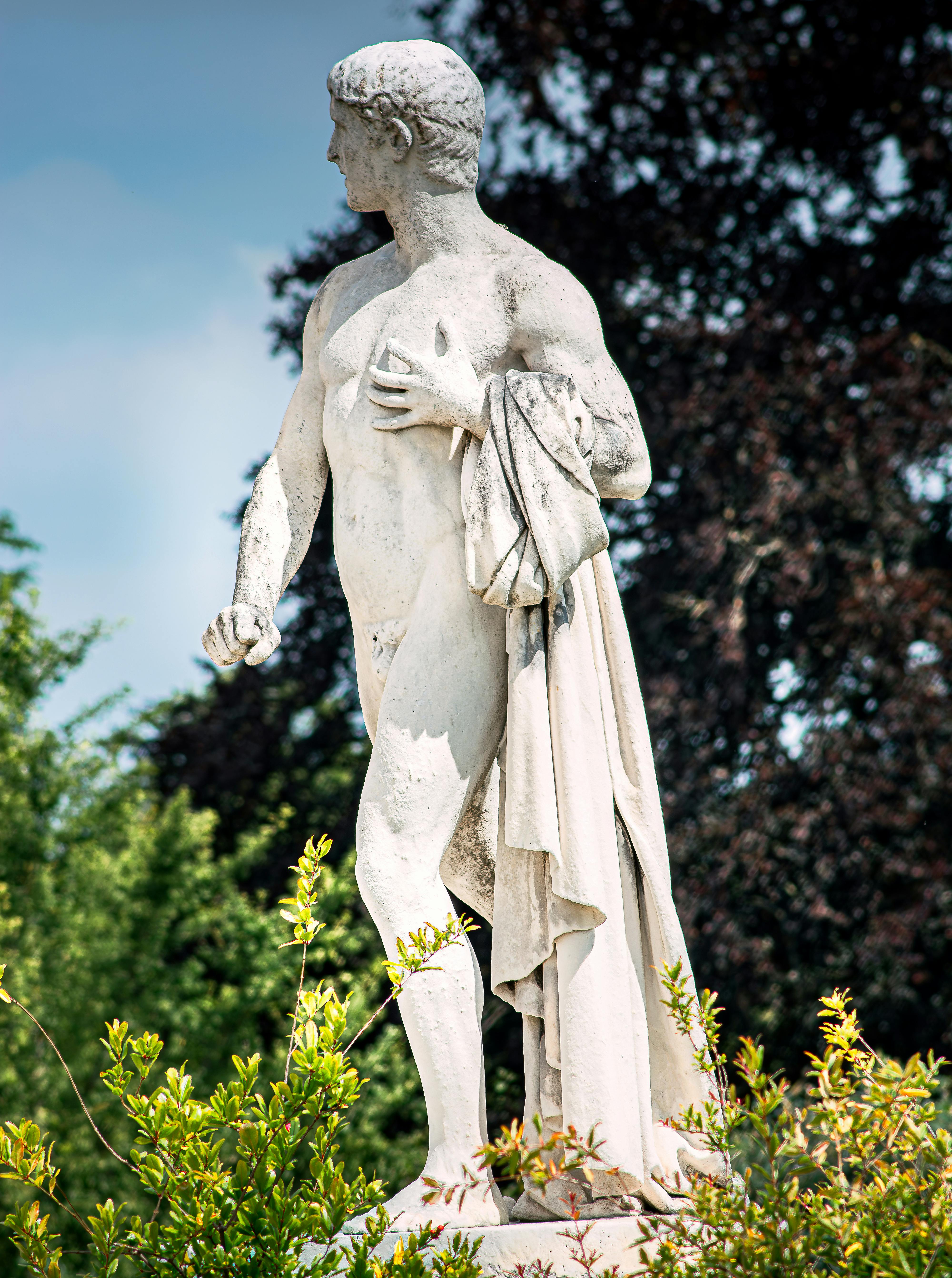 Classical Marble Statue in Lush Garden Setting · Free Stock Photo