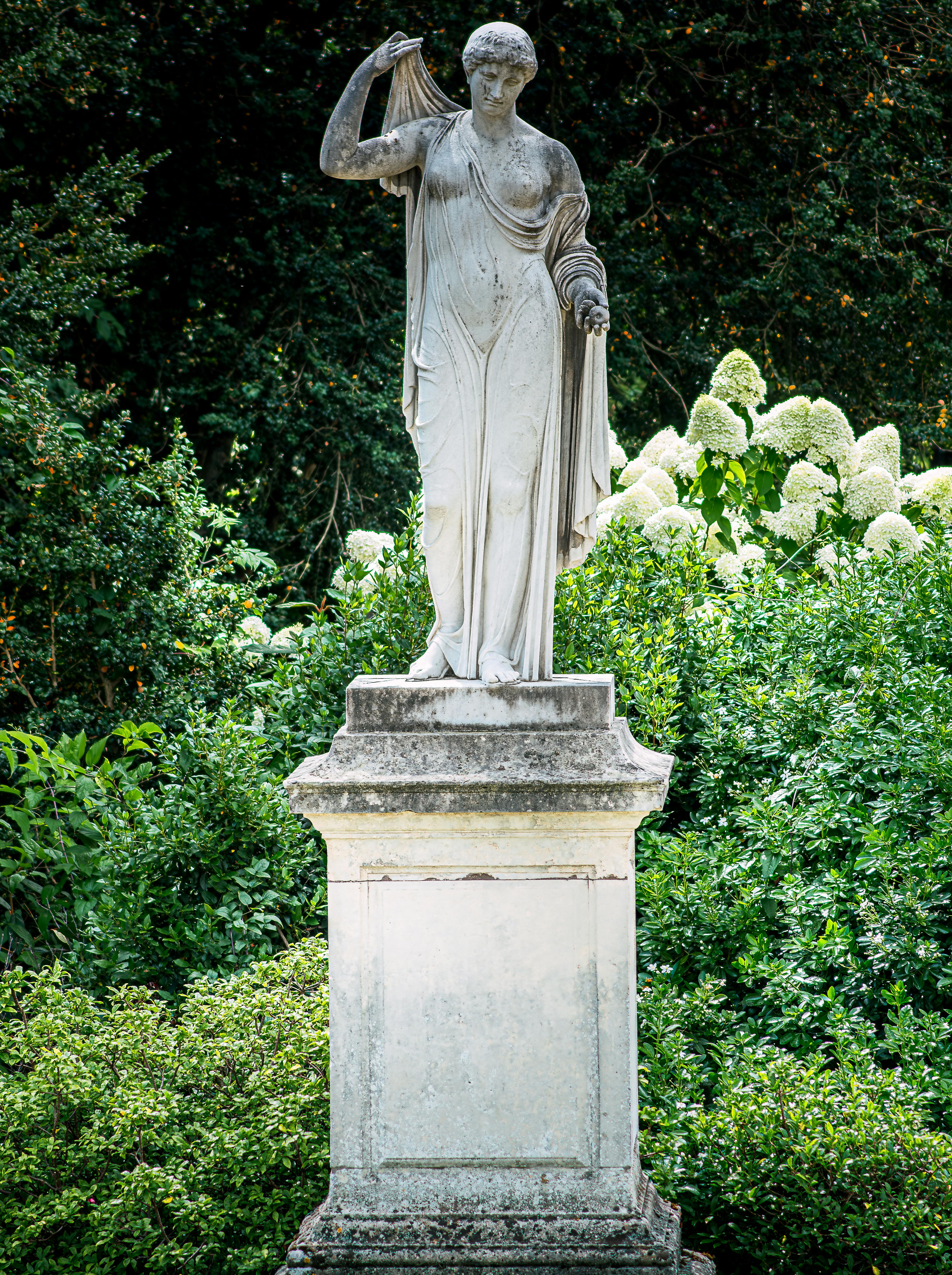 Classical Marble Statue in Lush Garden Setting · Free Stock Photo