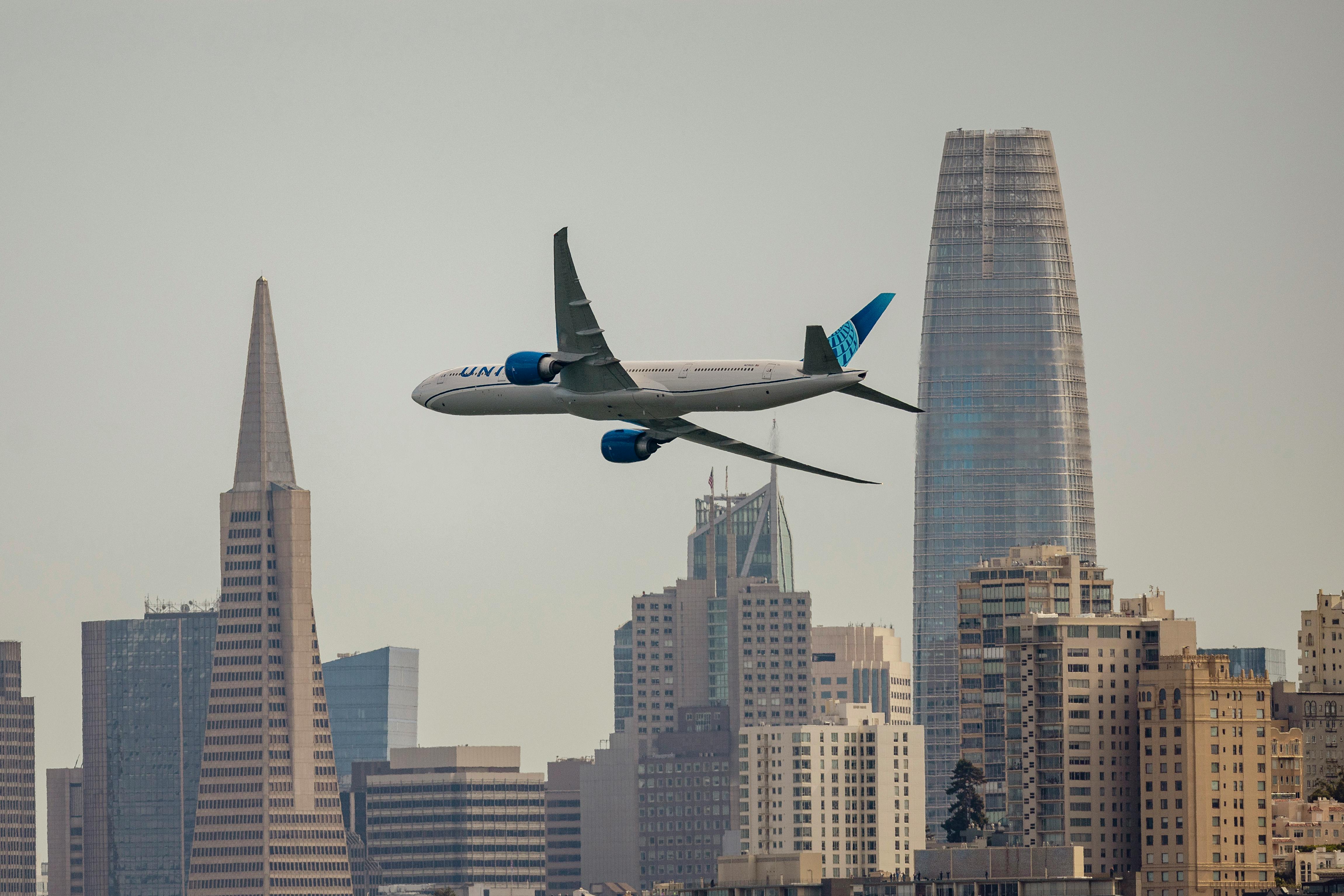 Airplane Flying Over San Francisco Skyline · Free Stock Photo