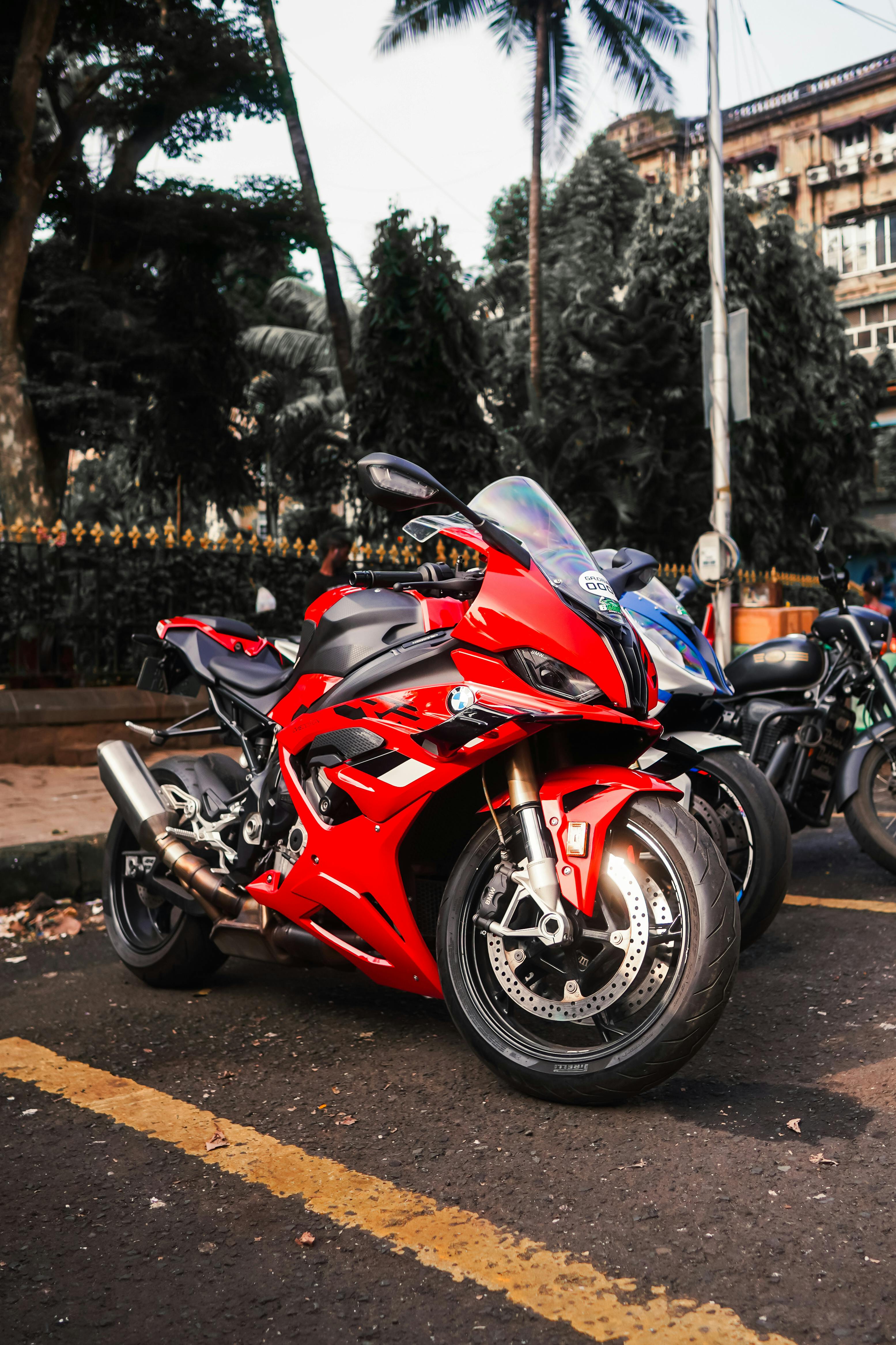Red Sports Motorcycle Parked on Urban Street · Free Stock Photo
