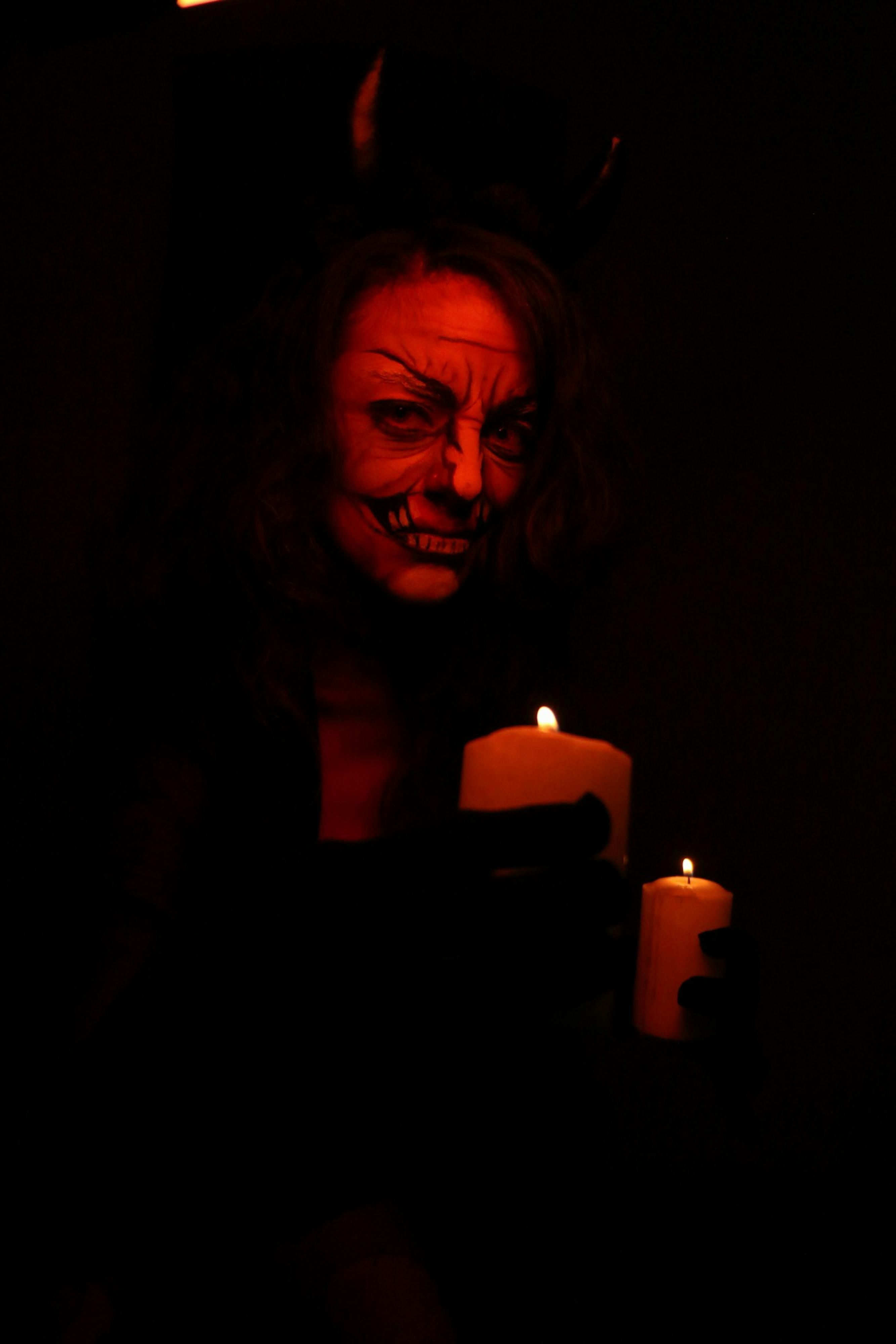 Spooky Candlelit Figure with Devil Mask · Free Stock Photo