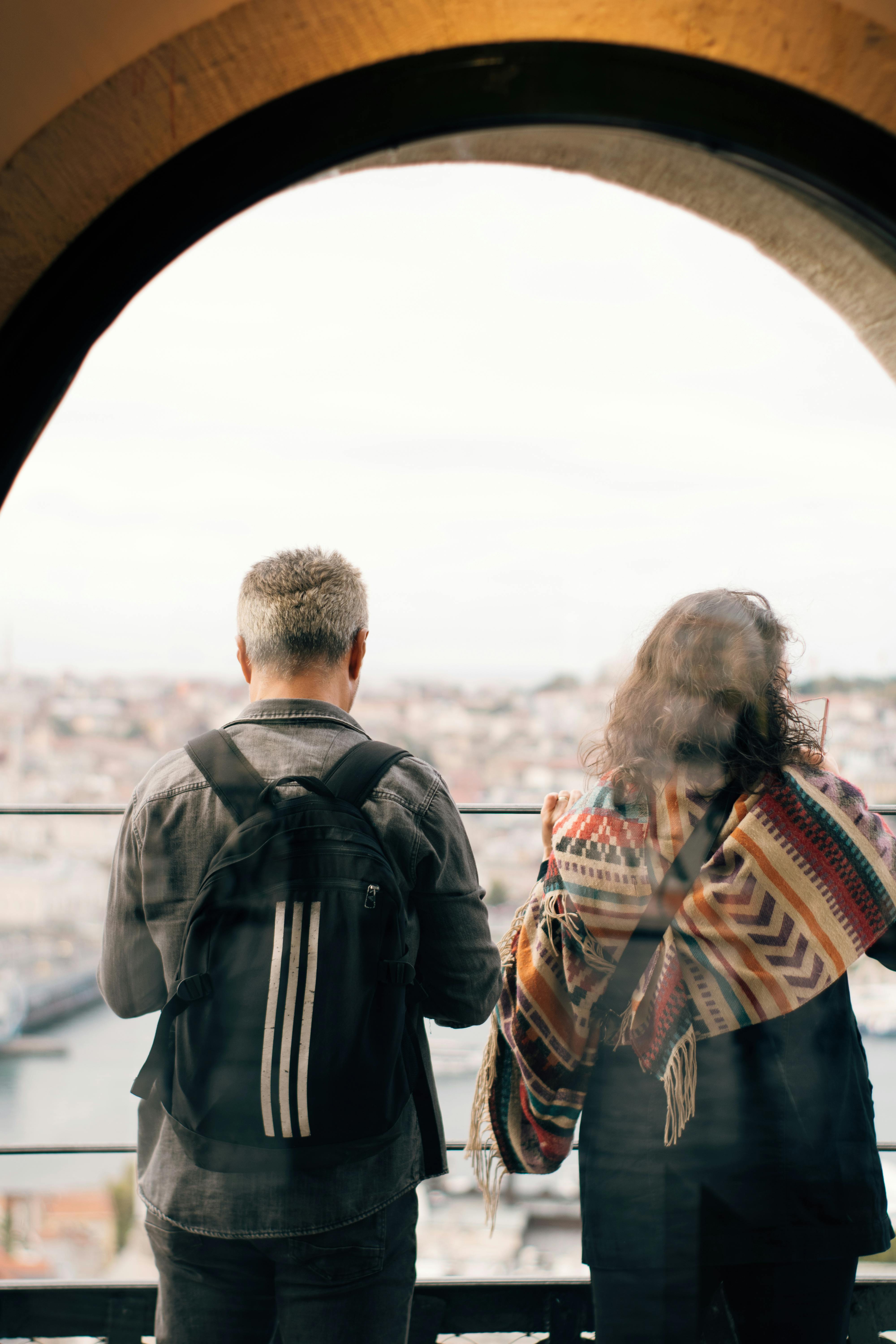 Tourists Enjoy Scenic View Through Archway · Free Stock Photo