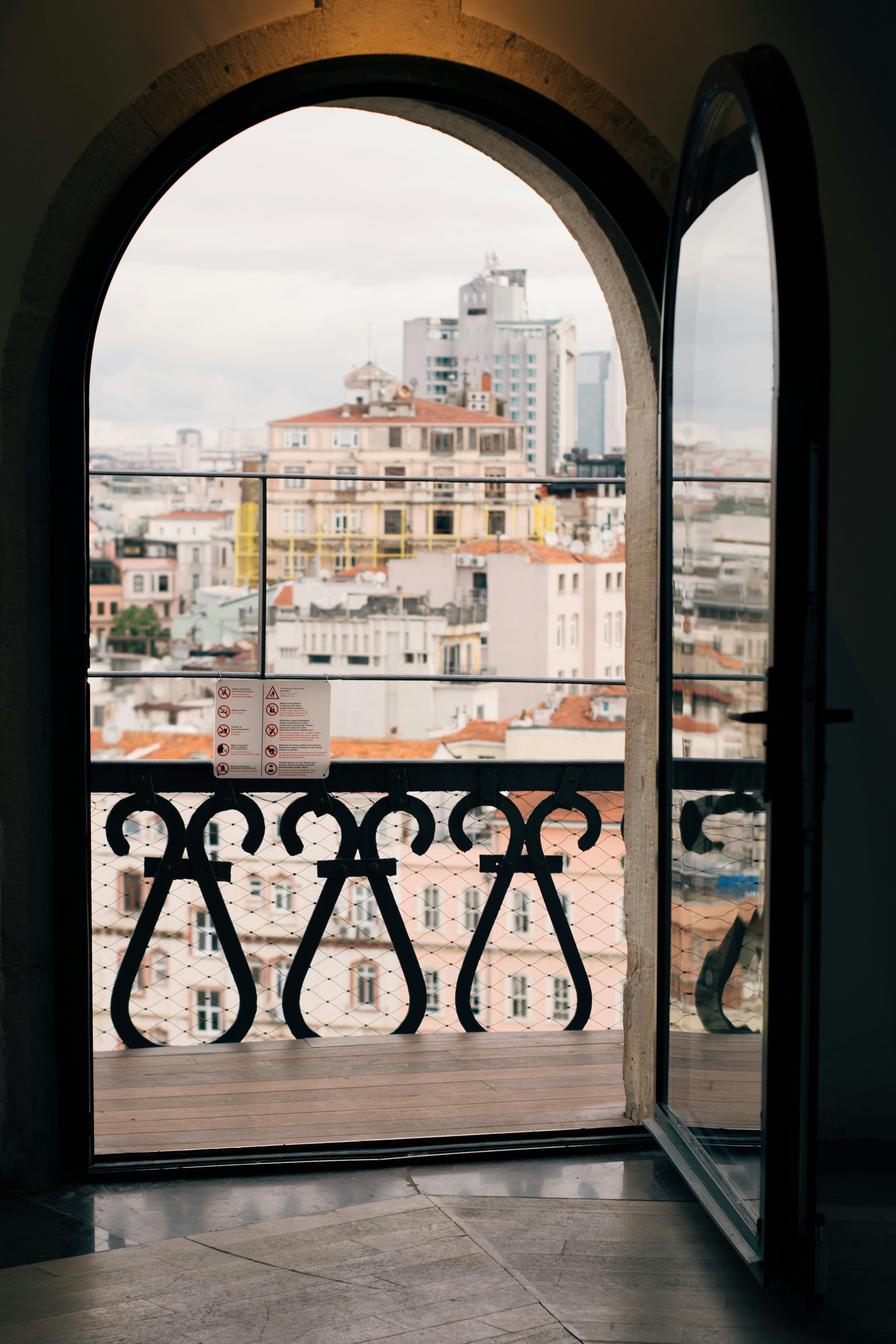 Arched Balcony View of Urban Cityscape · Free Stock Photo