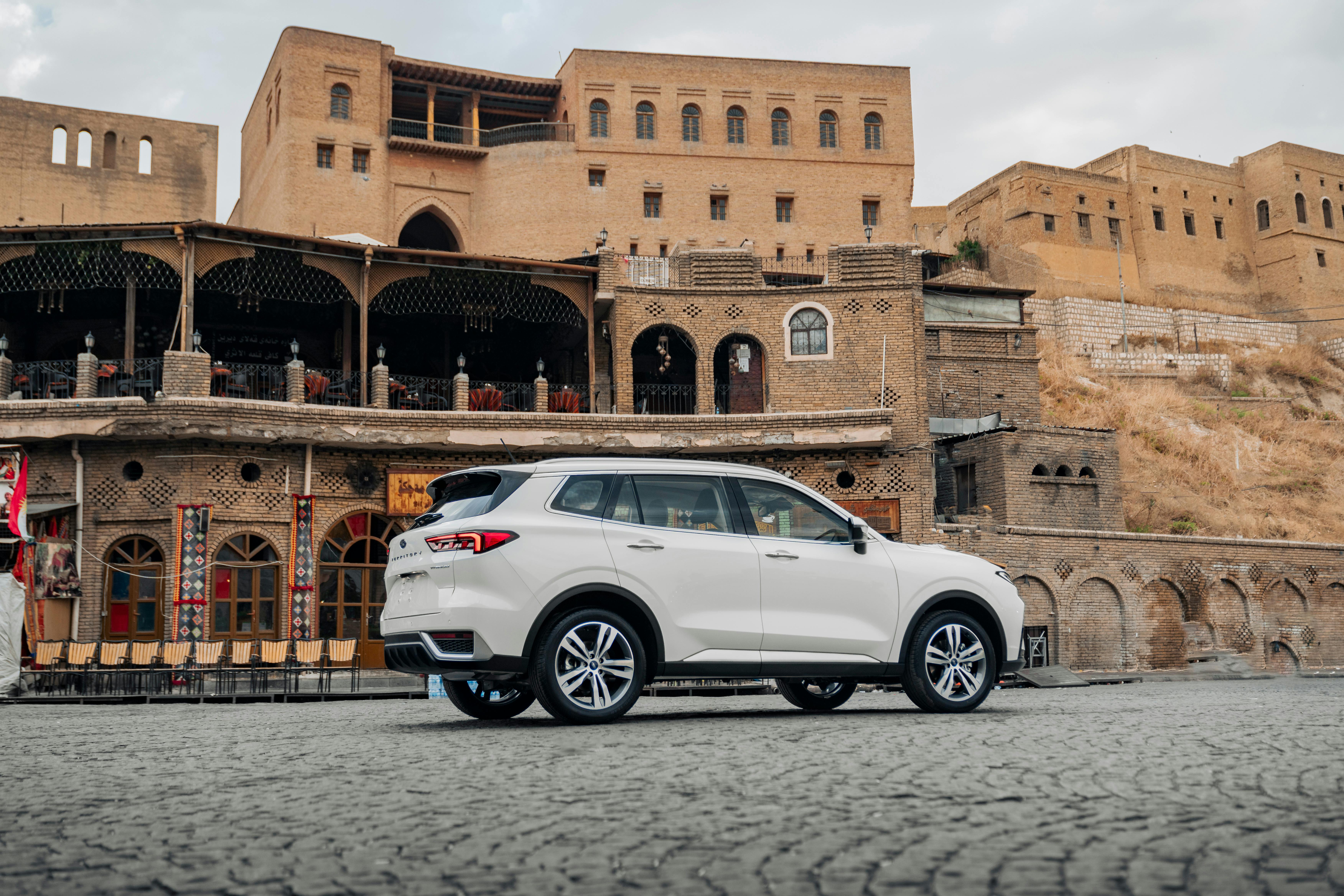 Modern SUV in Front of Historic Erbil Citadel · Free Stock Photo