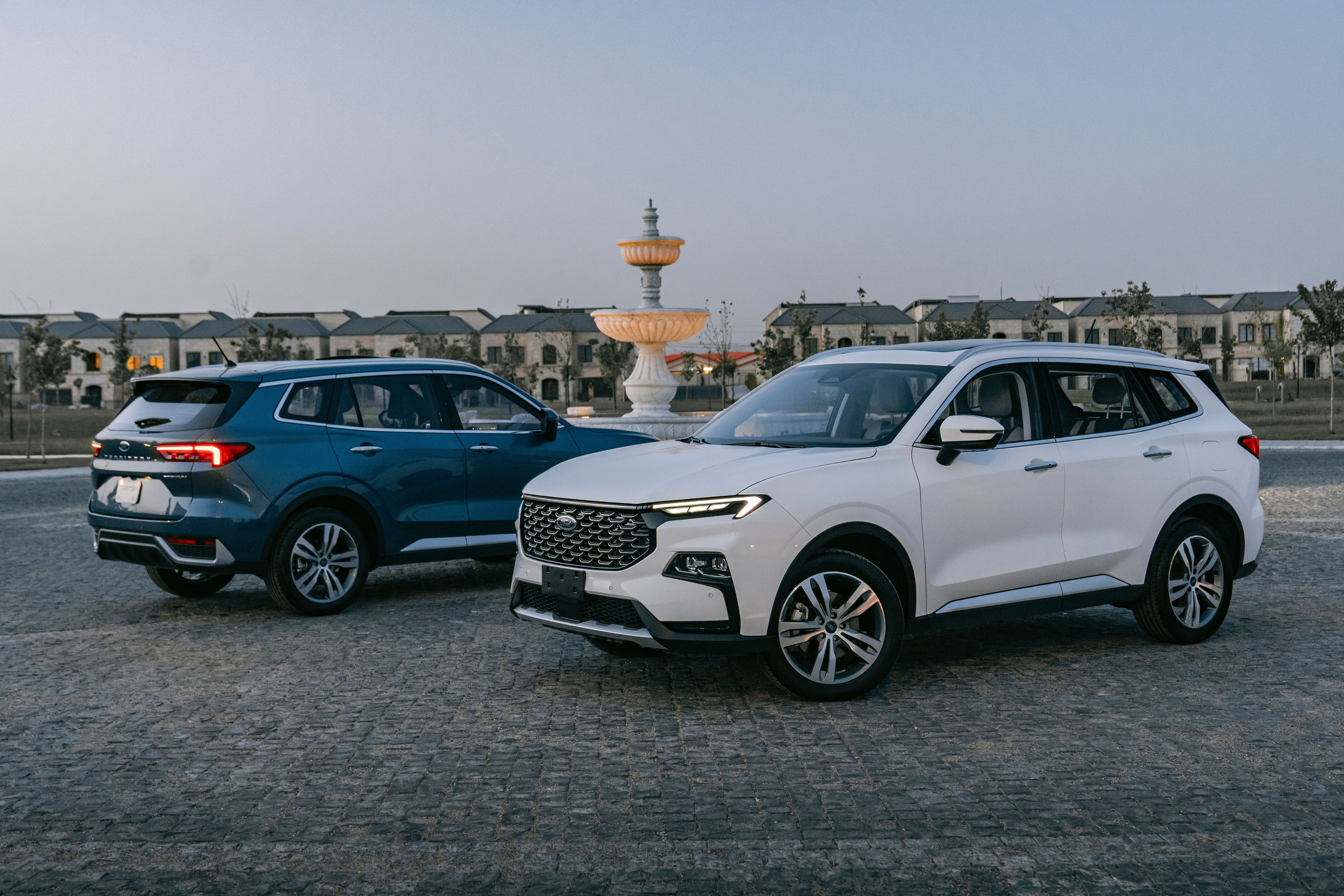 Modern SUVs in Urban Setting at Sunset · Free Stock Photo