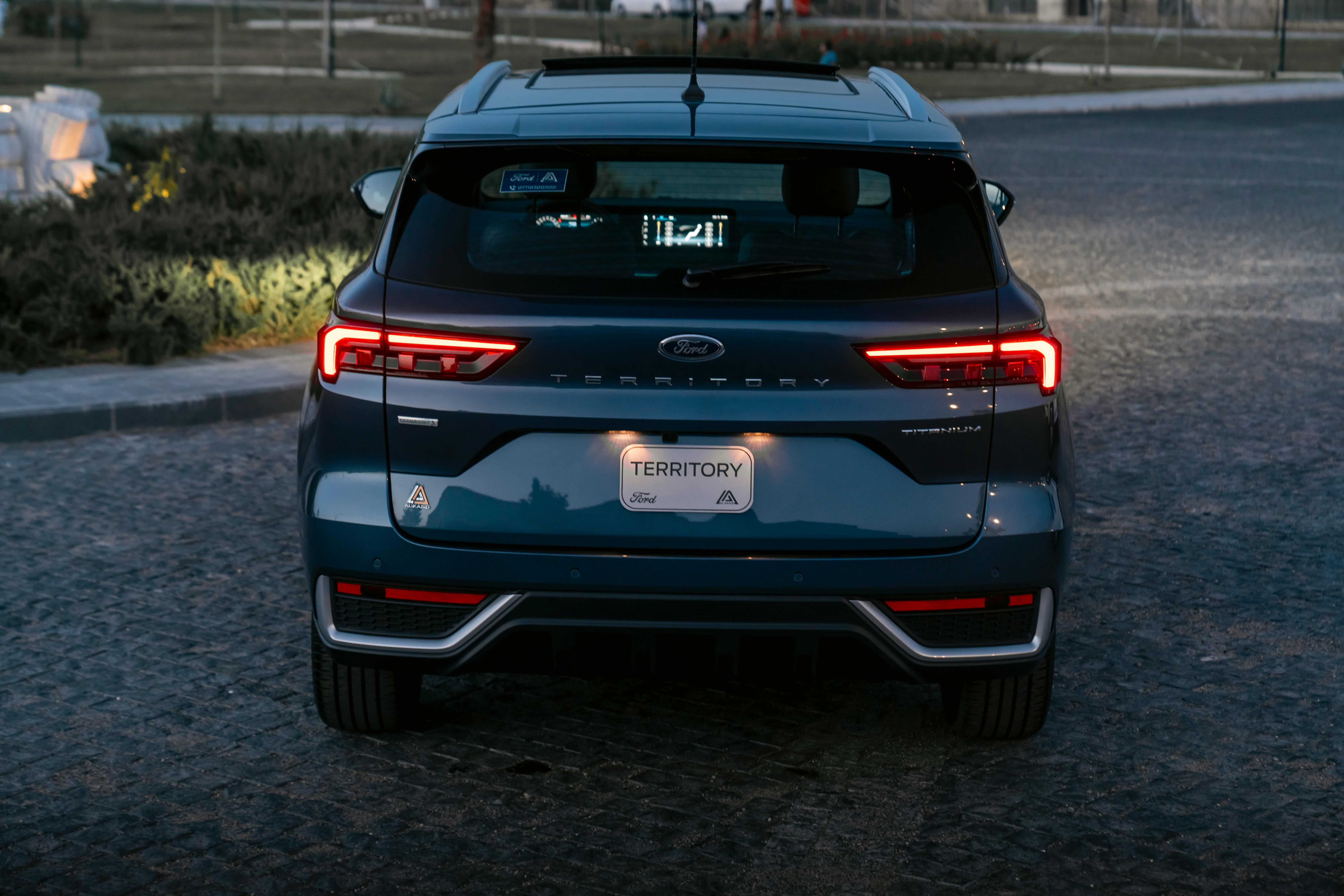 Rear View of a Modern SUV on a City Street · Free Stock Photo