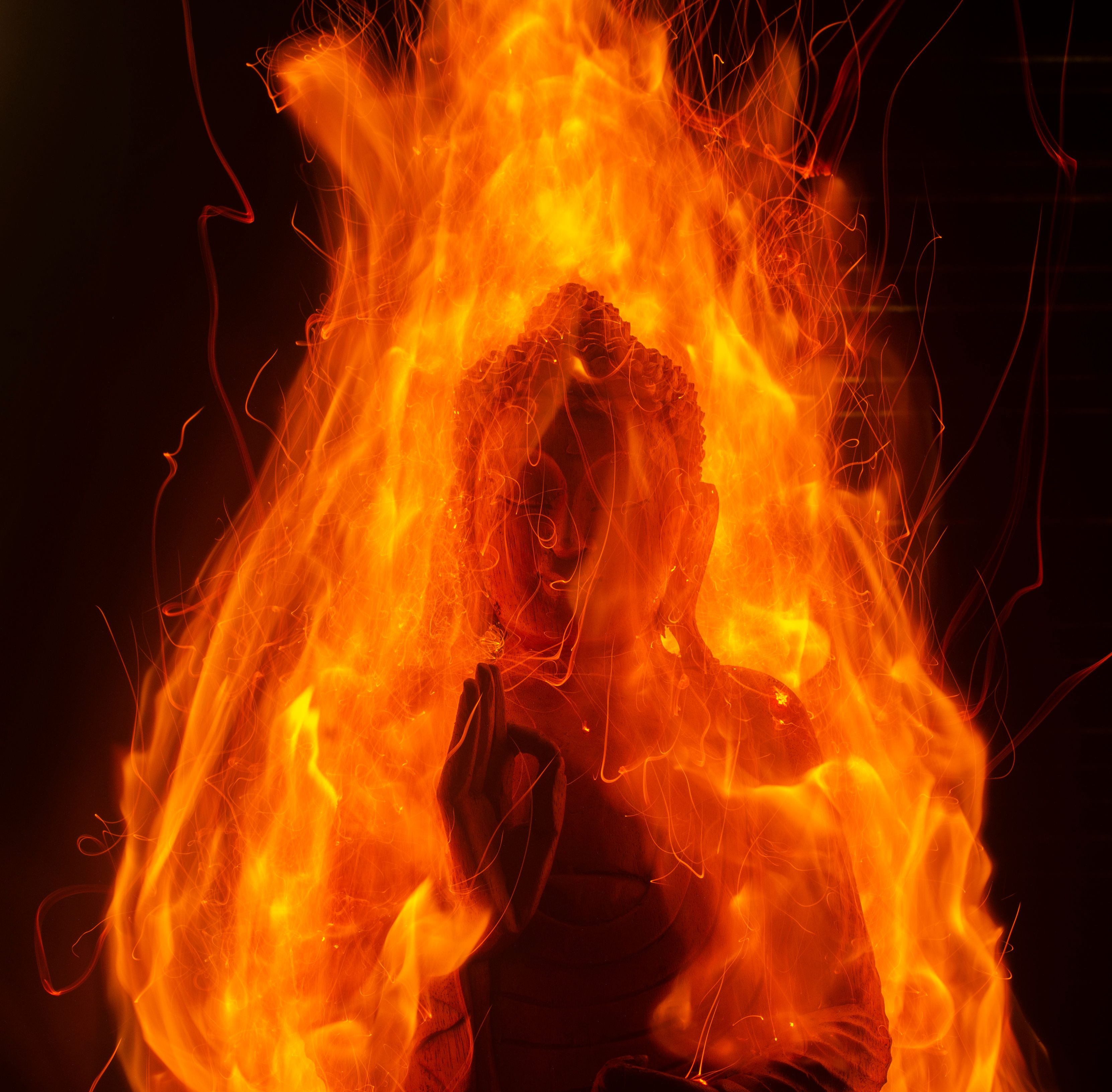Fiery Buddha Statue in Vibrant Flames · Free Stock Photo