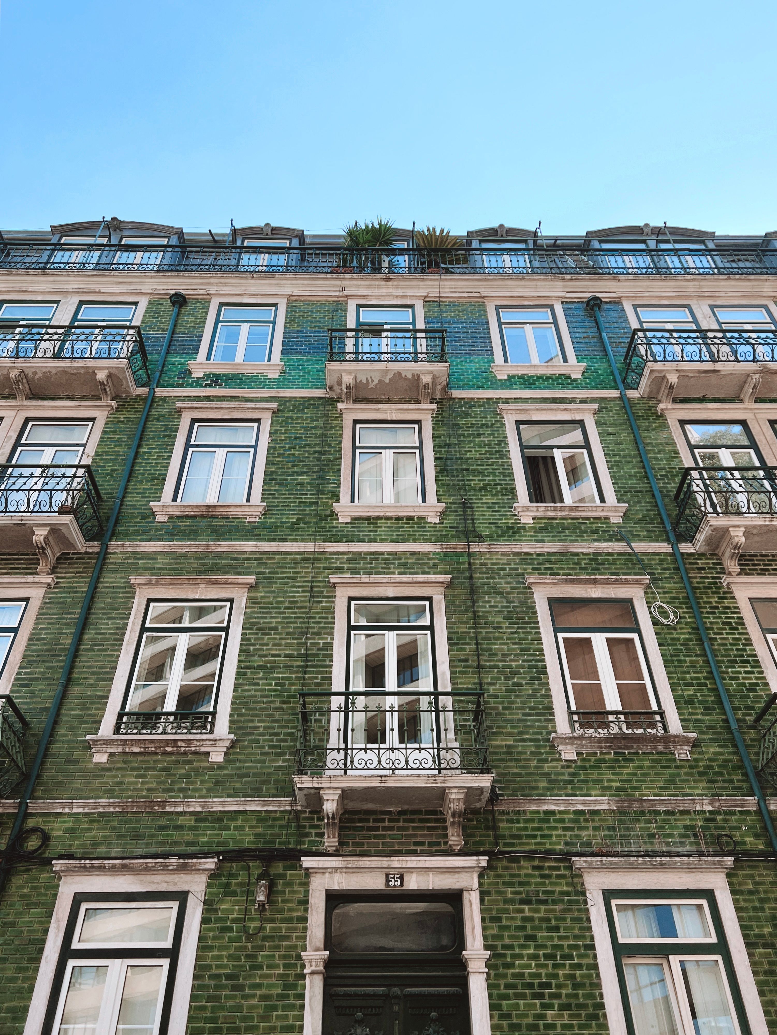 Green Brick Facade of European Apartment Building · Free Stock Photo