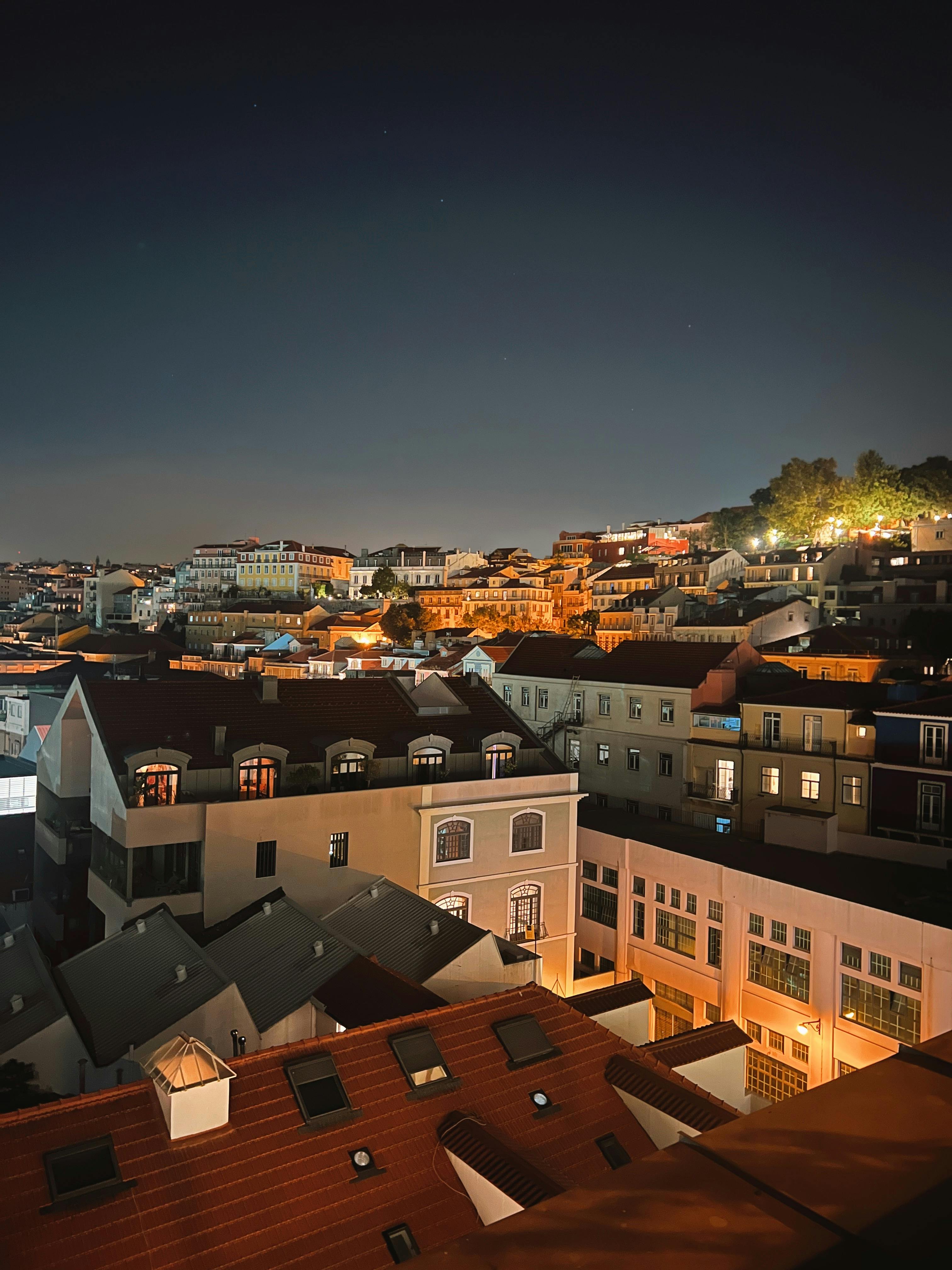 Nighttime Rooftop View of Lisbon Cityscape · Free Stock Photo