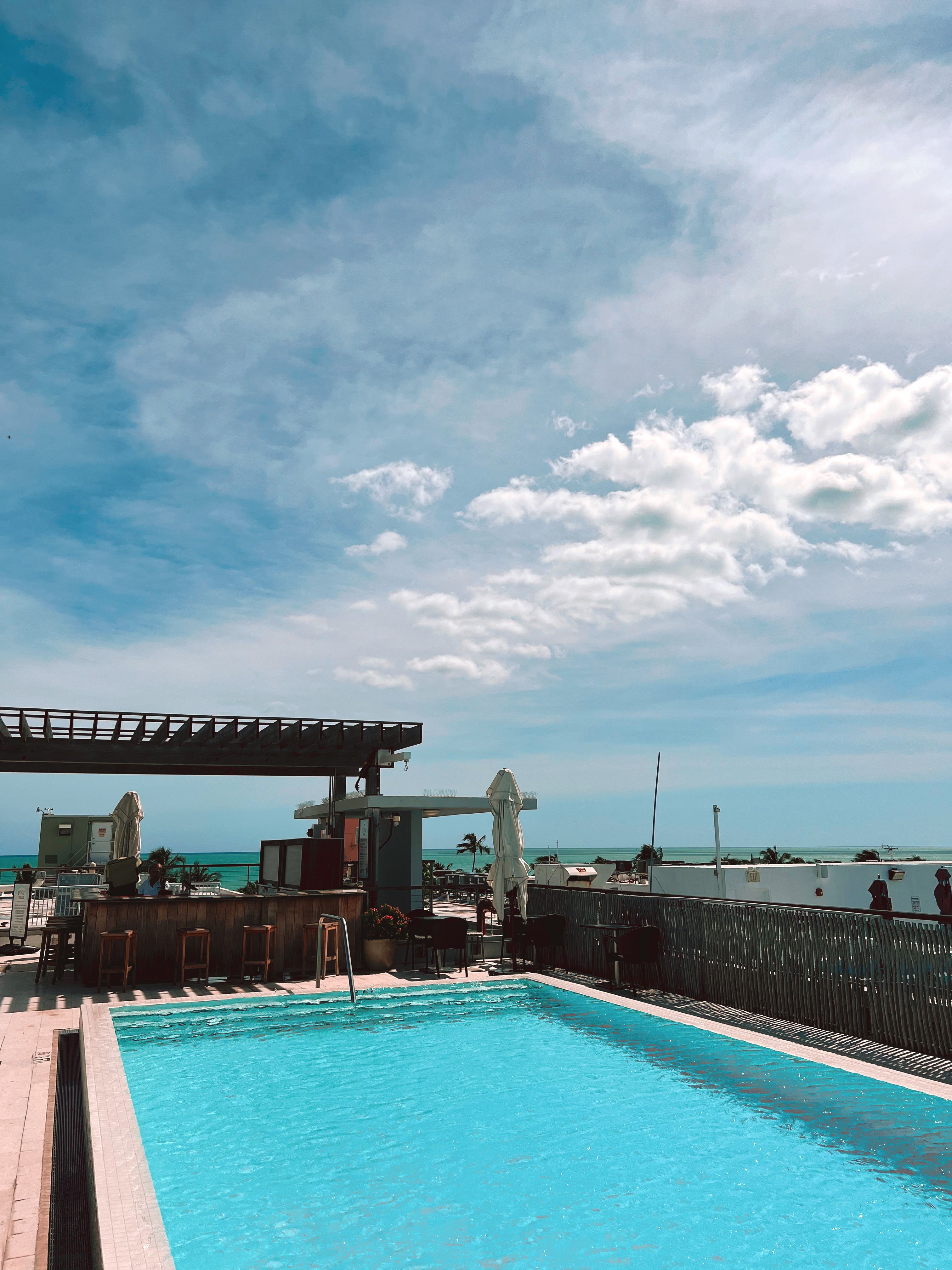 Sunny Rooftop Pool with Ocean View · Free Stock Photo