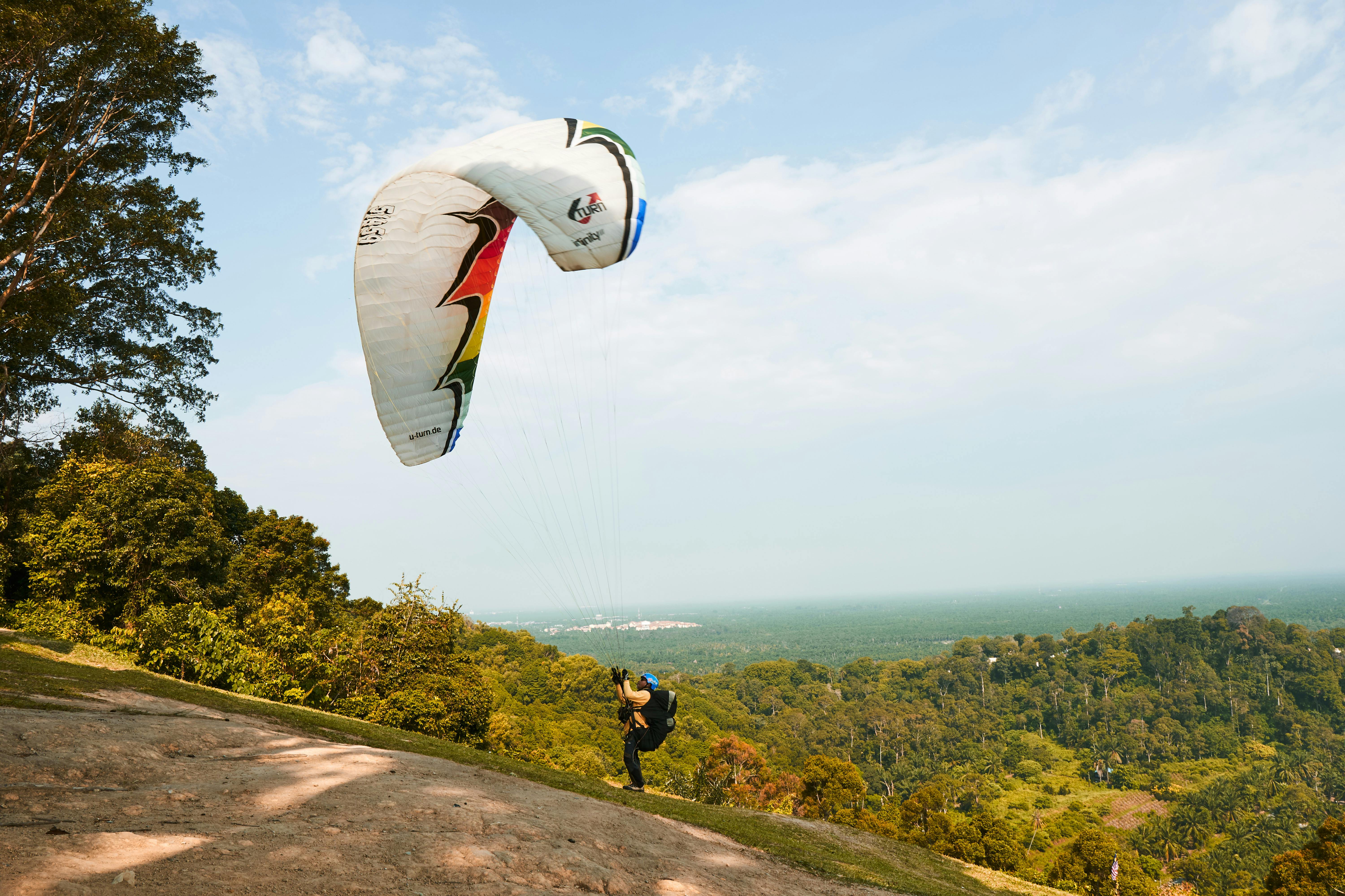 Man Holding Onto Parachute · Free Stock Photo