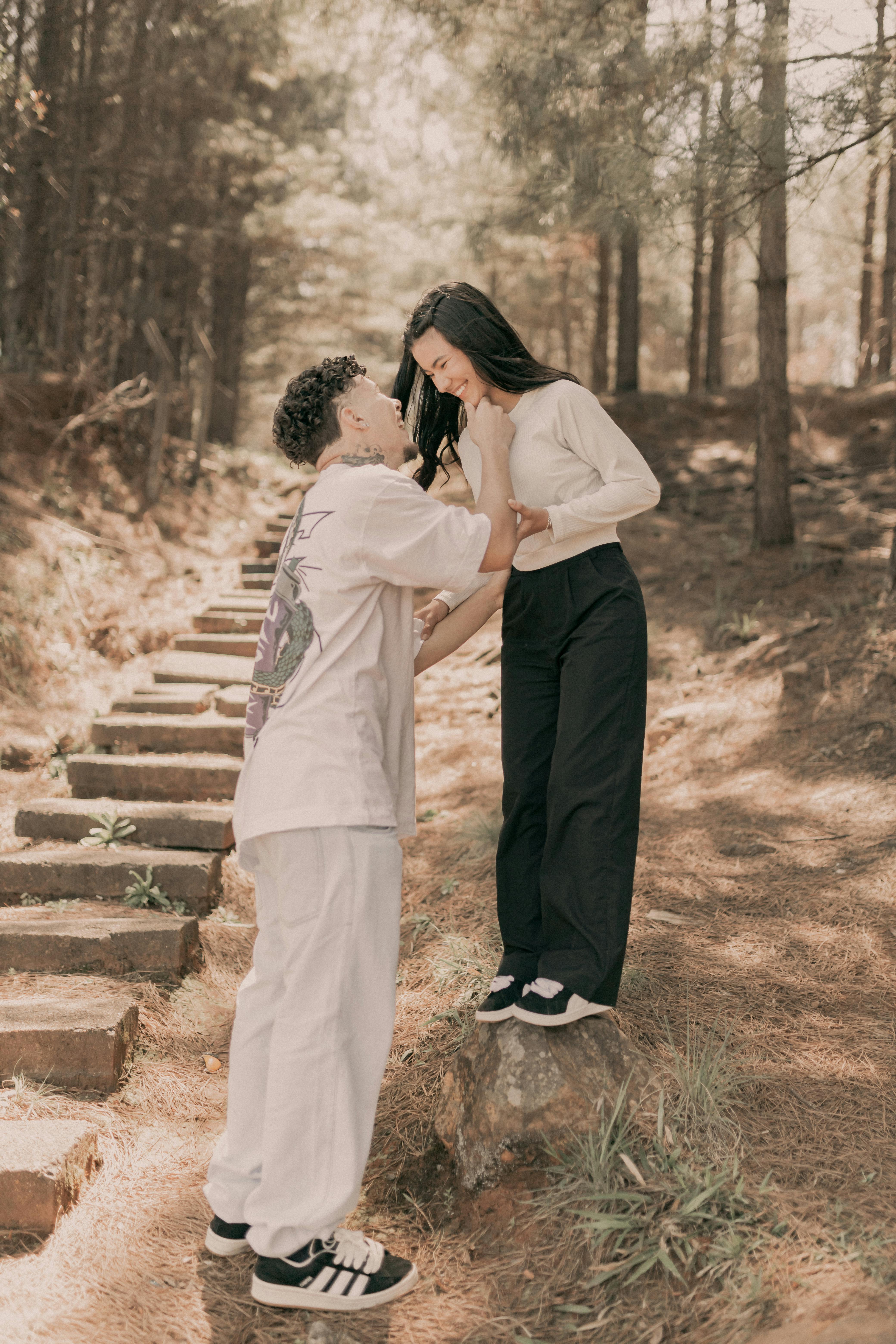 Young Couple Enjoying a Forest Stroll · Free Stock Photo
