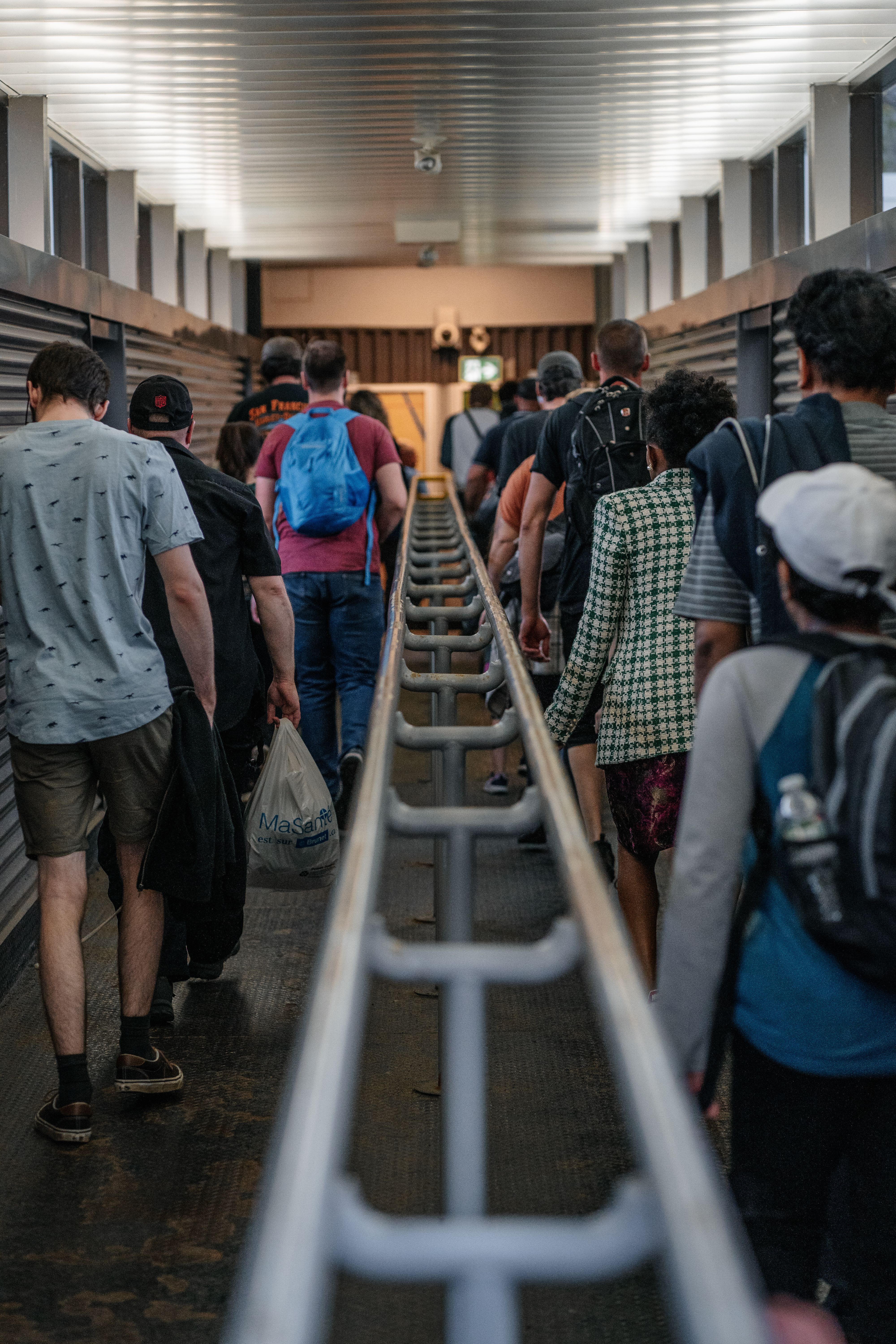 People Walking on Indoor Walkway with Railings · Free Stock Photo