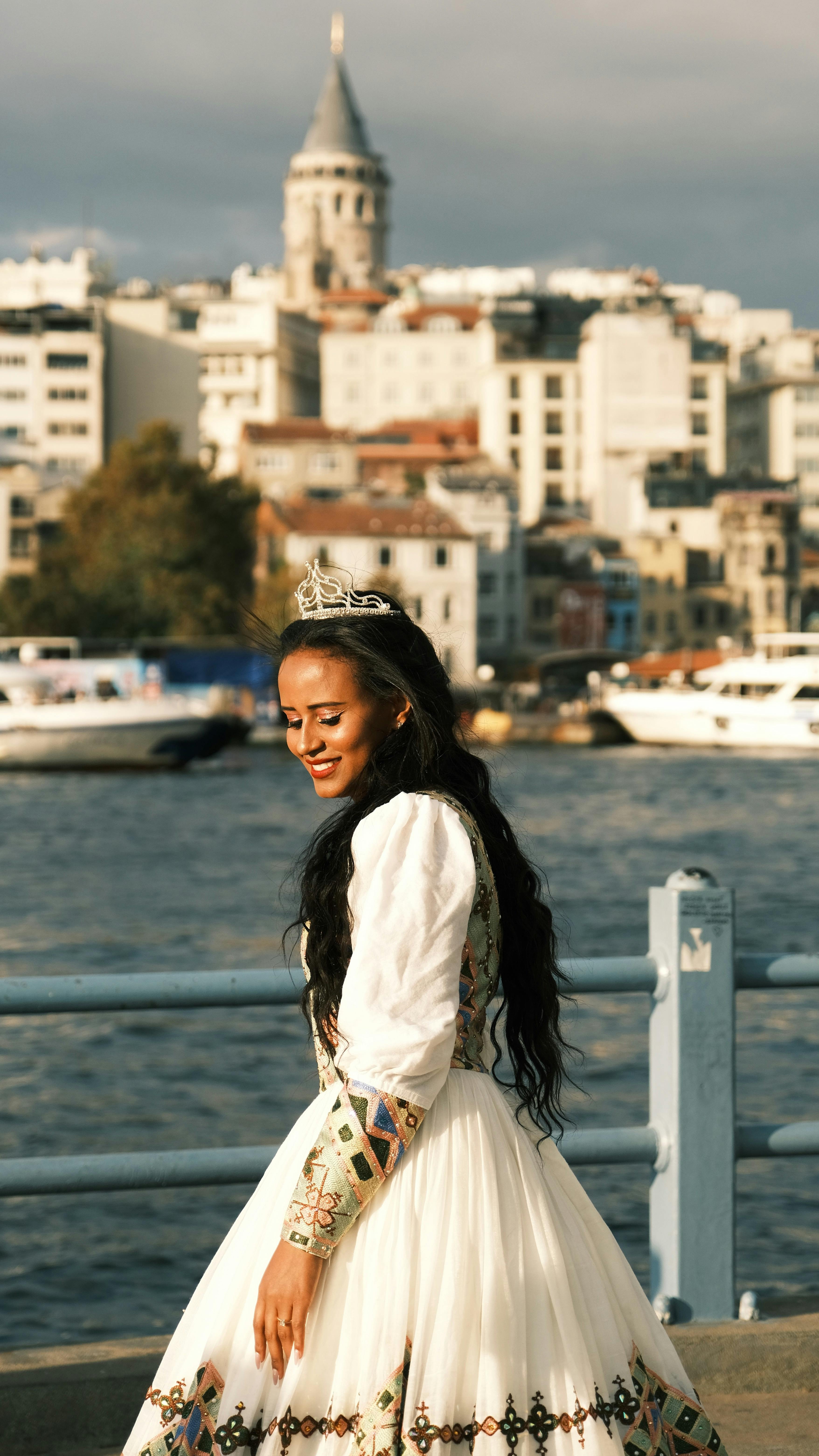 Young woman in traditional dress by Istanbul waterfront · Free Stock Photo