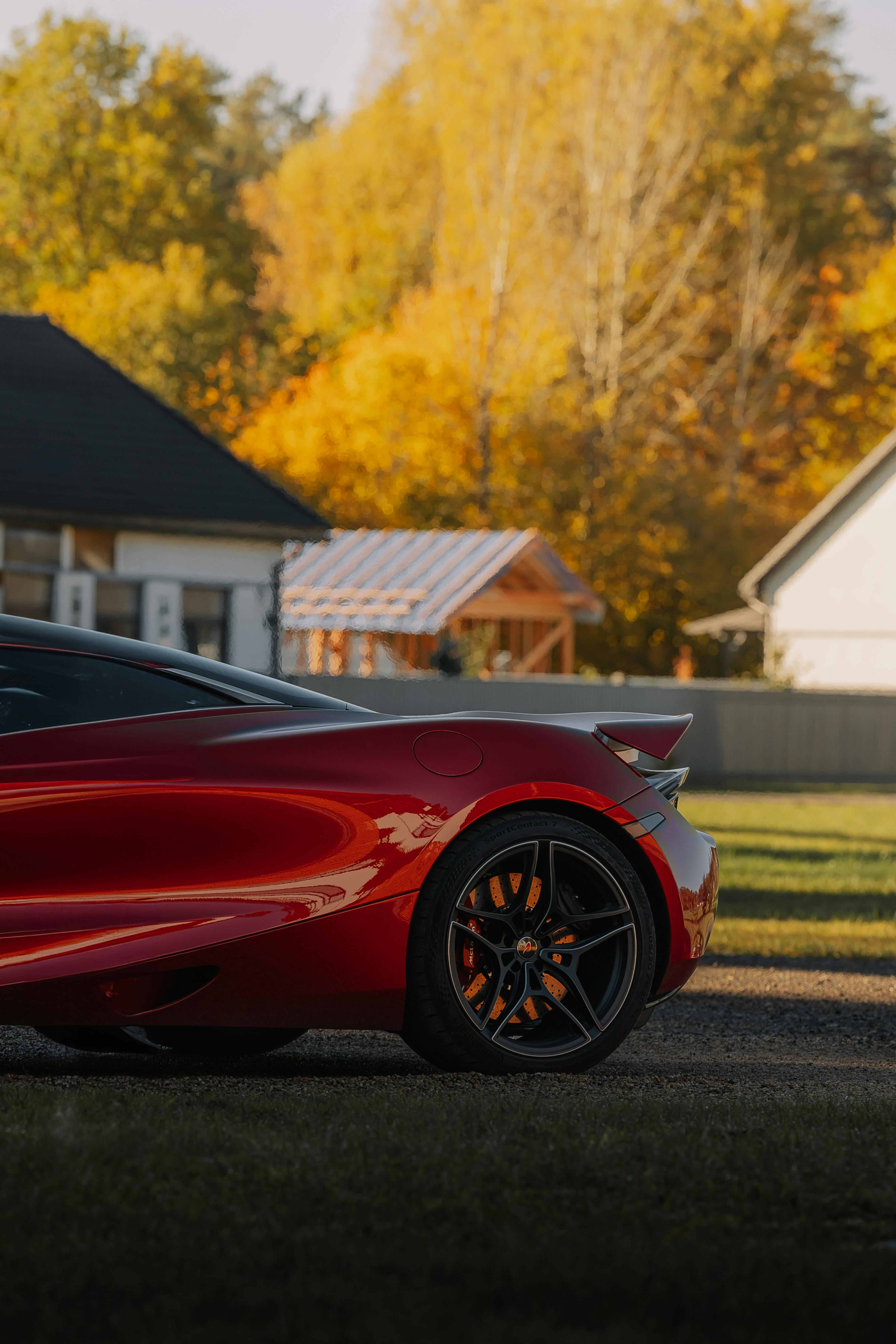Sleek Red Sports Car in Autumn Setting · Free Stock Photo