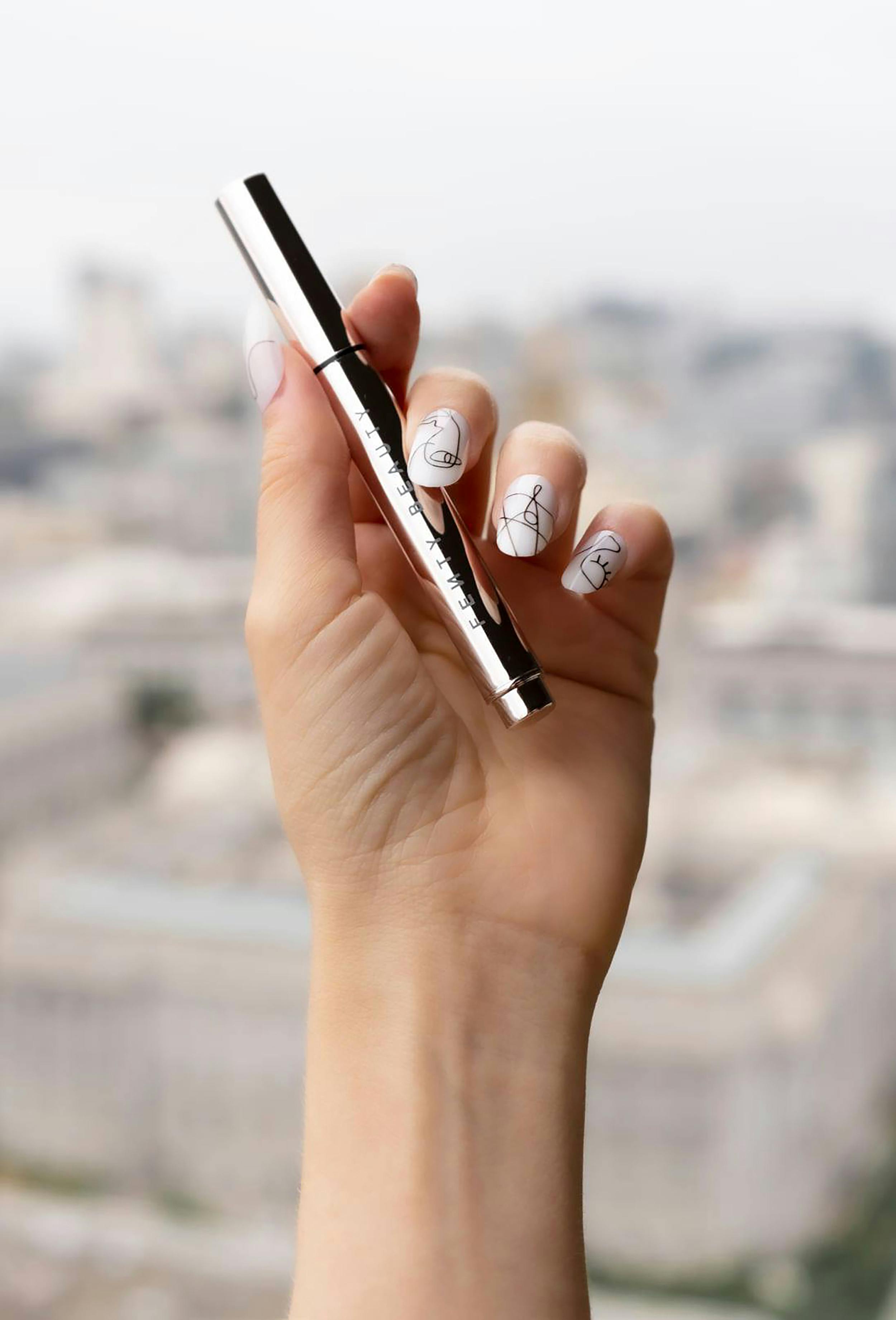 Elegant Nail Art with Pen in Hand Close-Up · Free Stock Photo