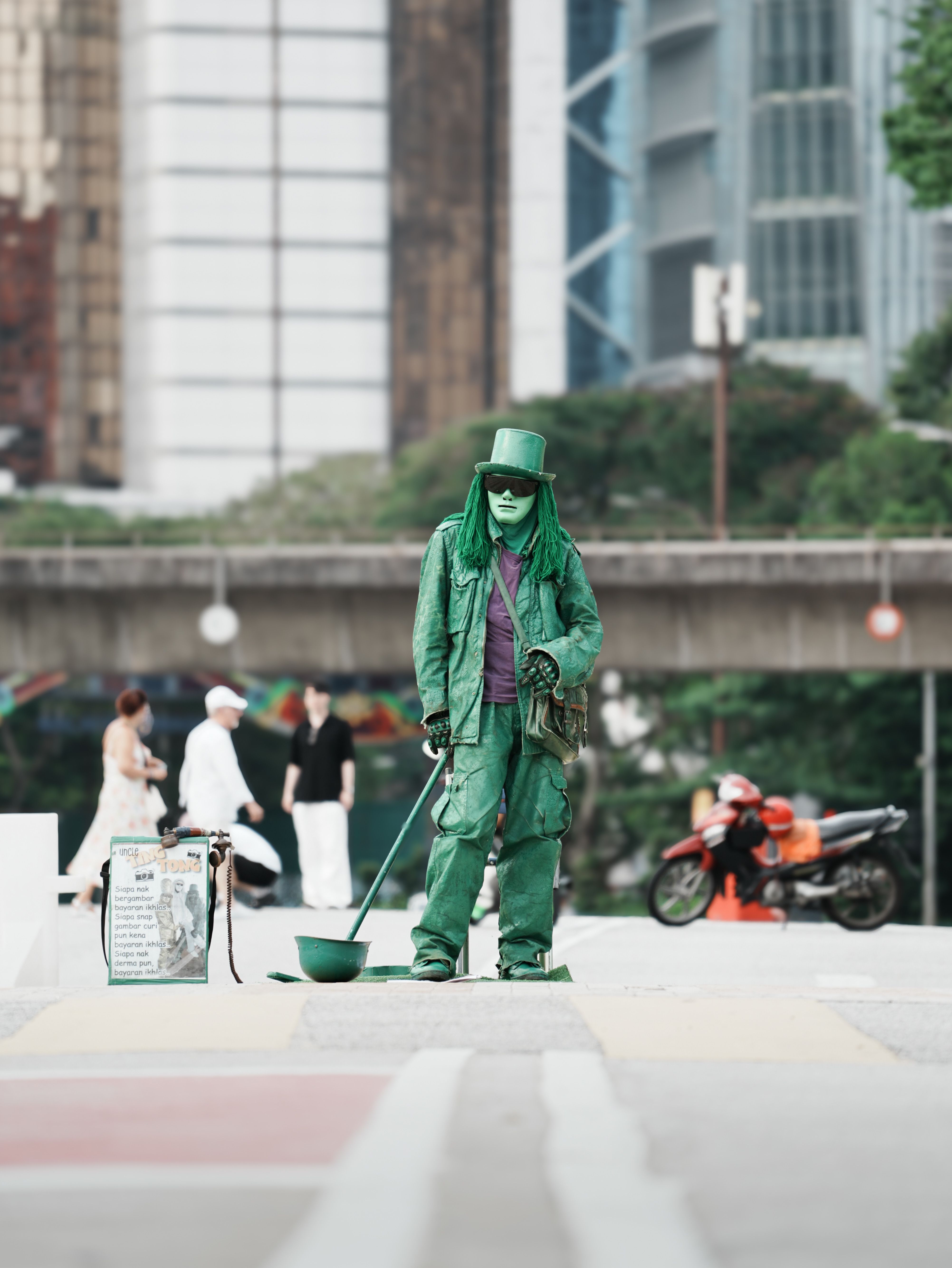 Street Performer in Green Costume in Urban Setting · Free Stock Photo