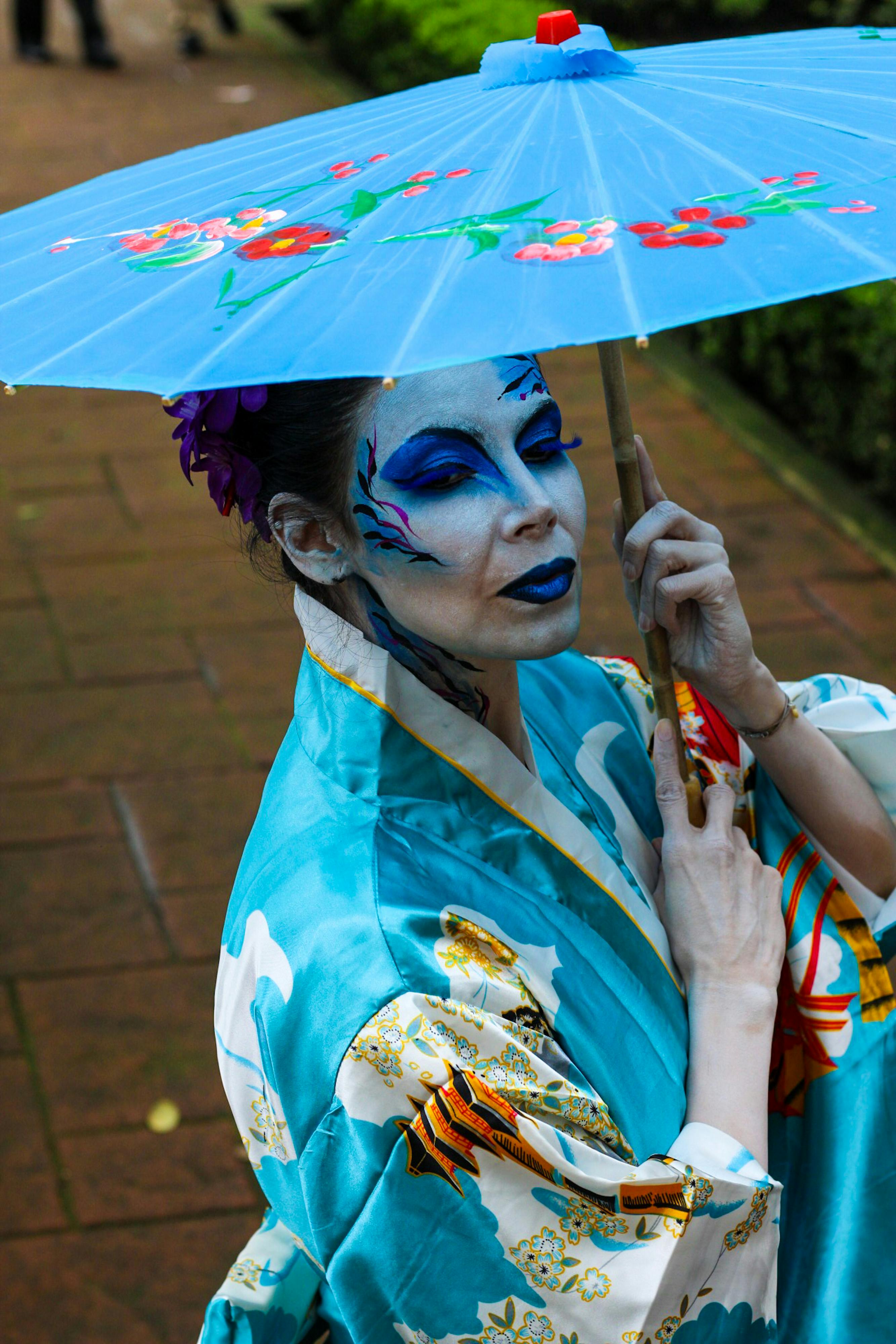 Elegant Geisha with Parasol in Blue Kimono · Free Stock Photo