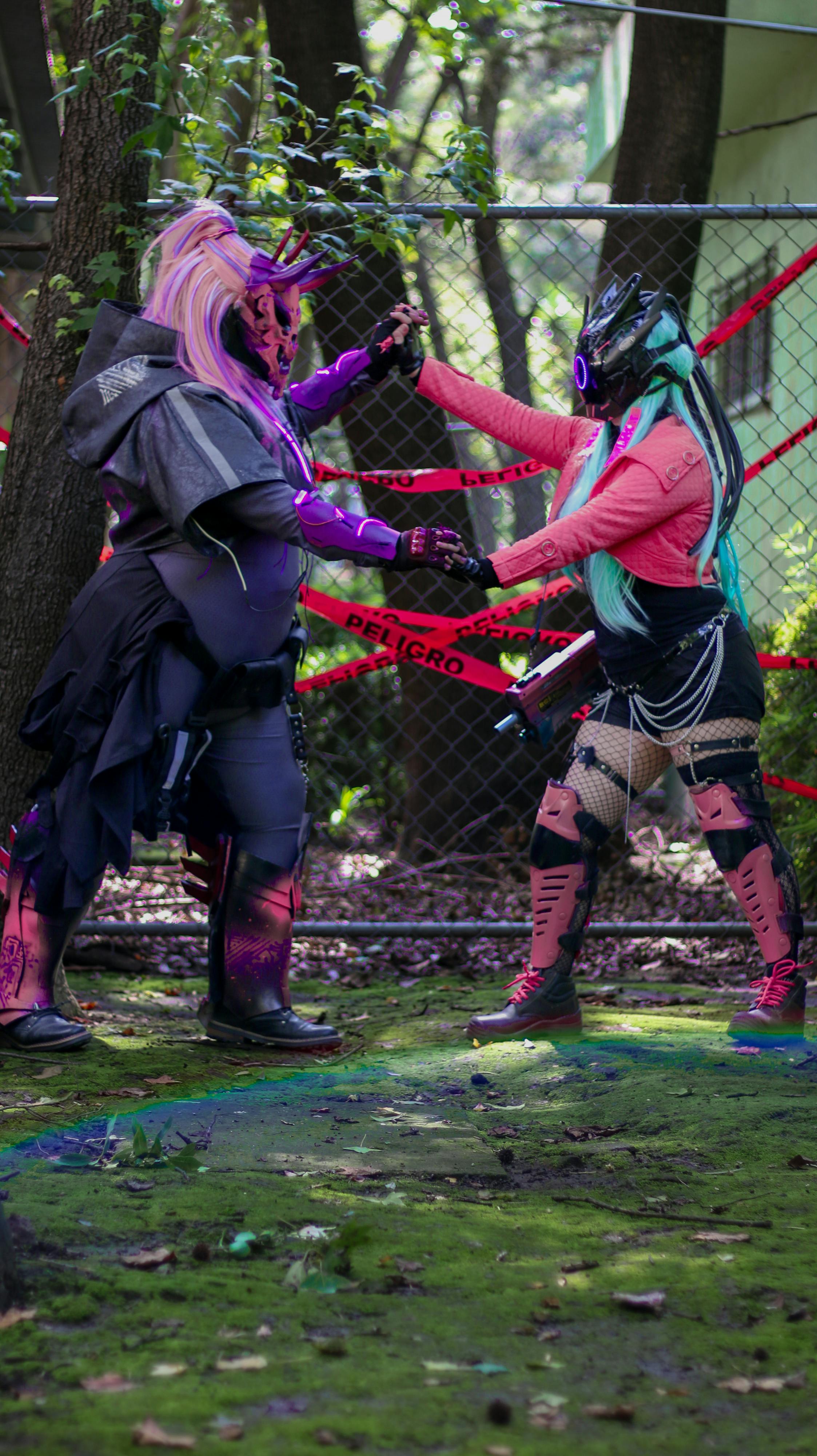 Colorful Cosplay Duel in Urban Park Setting · Free Stock Photo