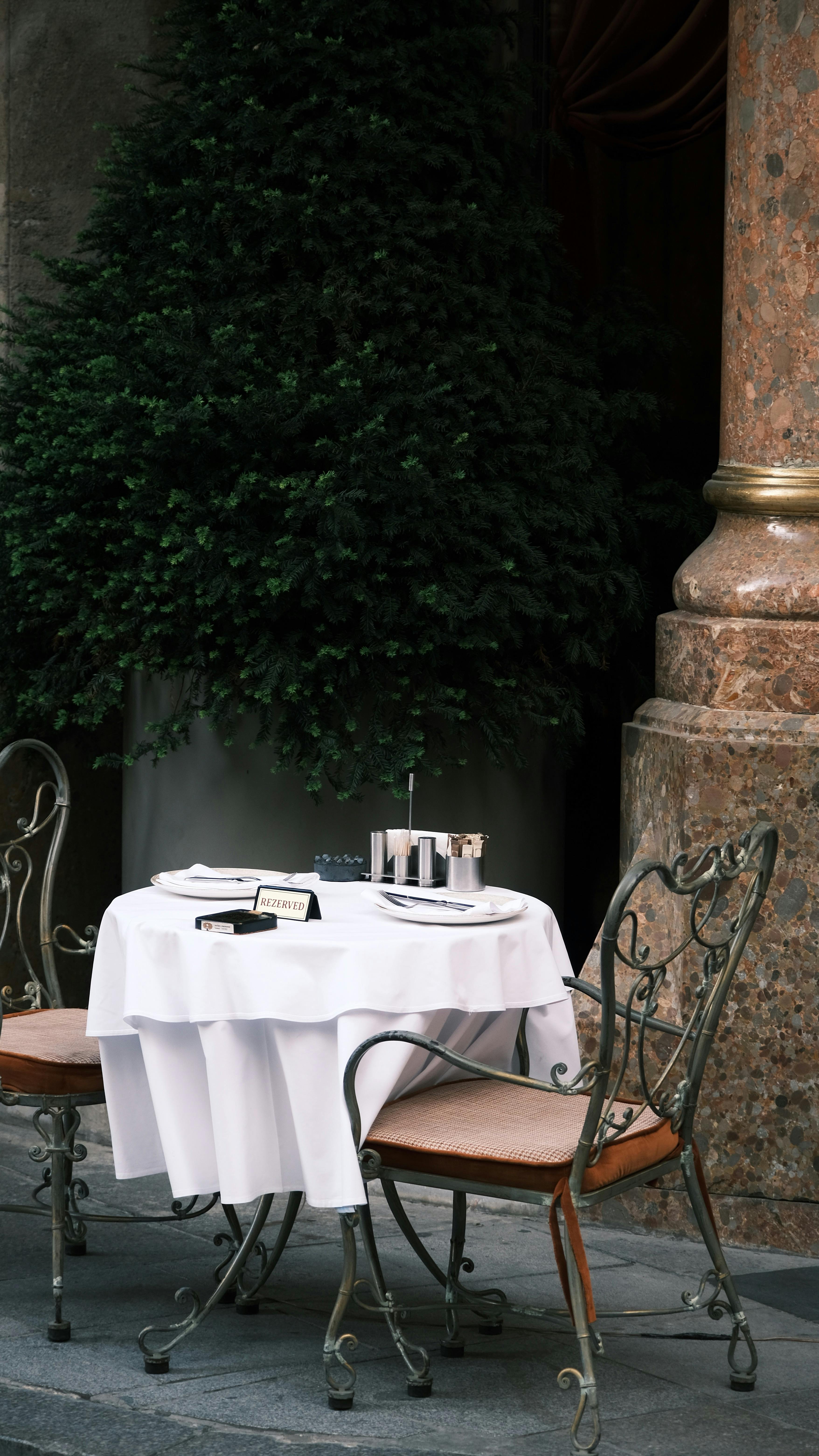Elegant Outdoor Café Table Setting with Chairs · Free Stock Photo