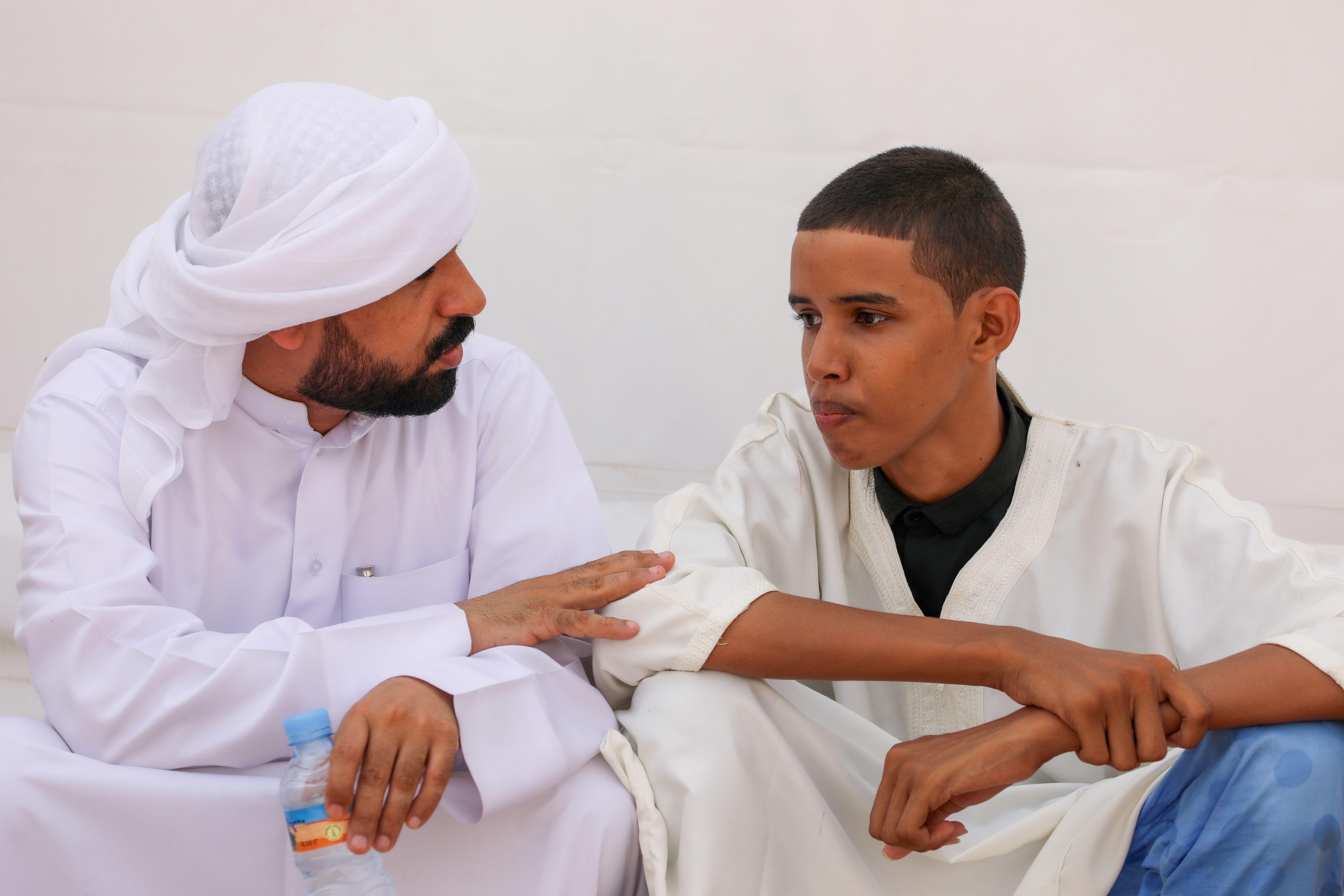 Middle Eastern Men in Traditional Clothing Conversing · Free Stock Photo