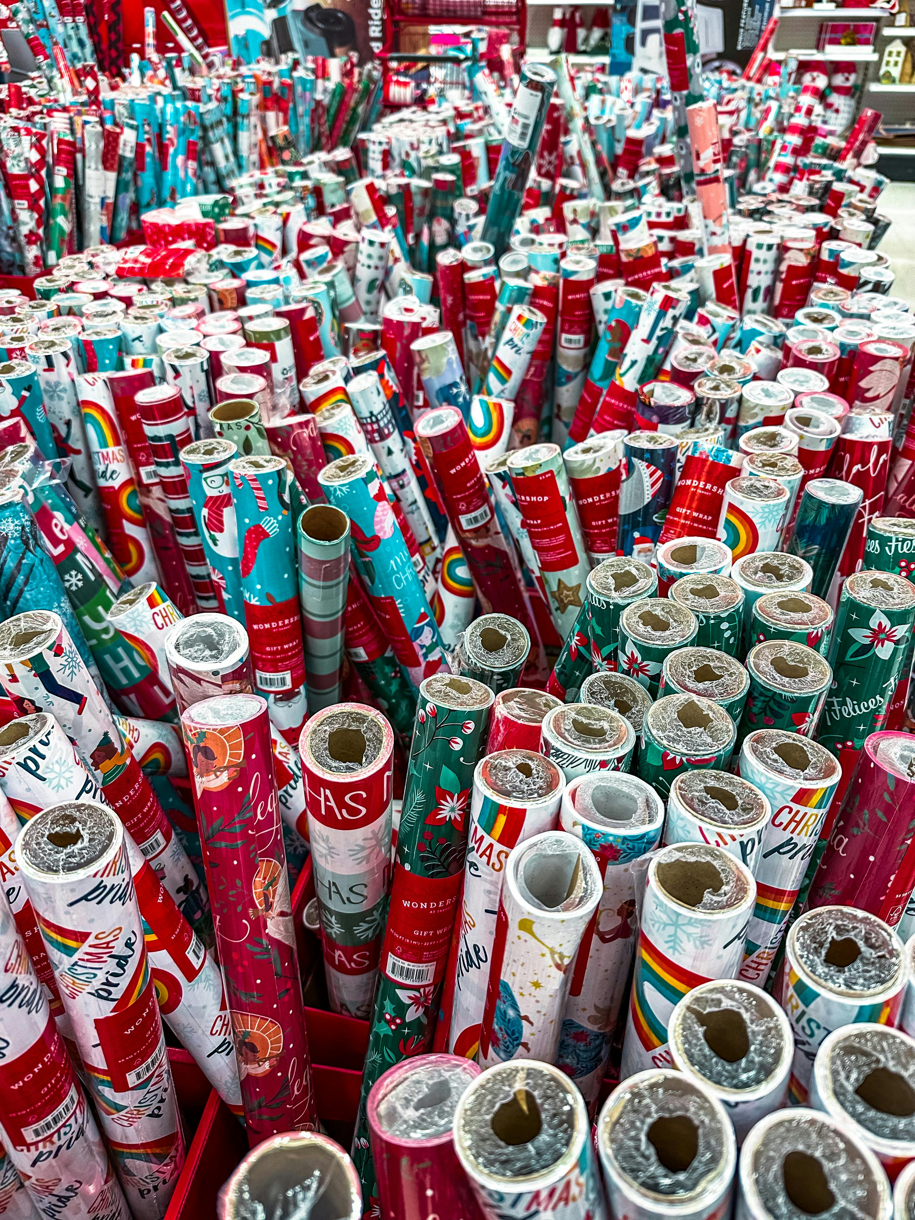 Colorful Assortment of Christmas Wrapping Paper Rolls · Free Stock Photo