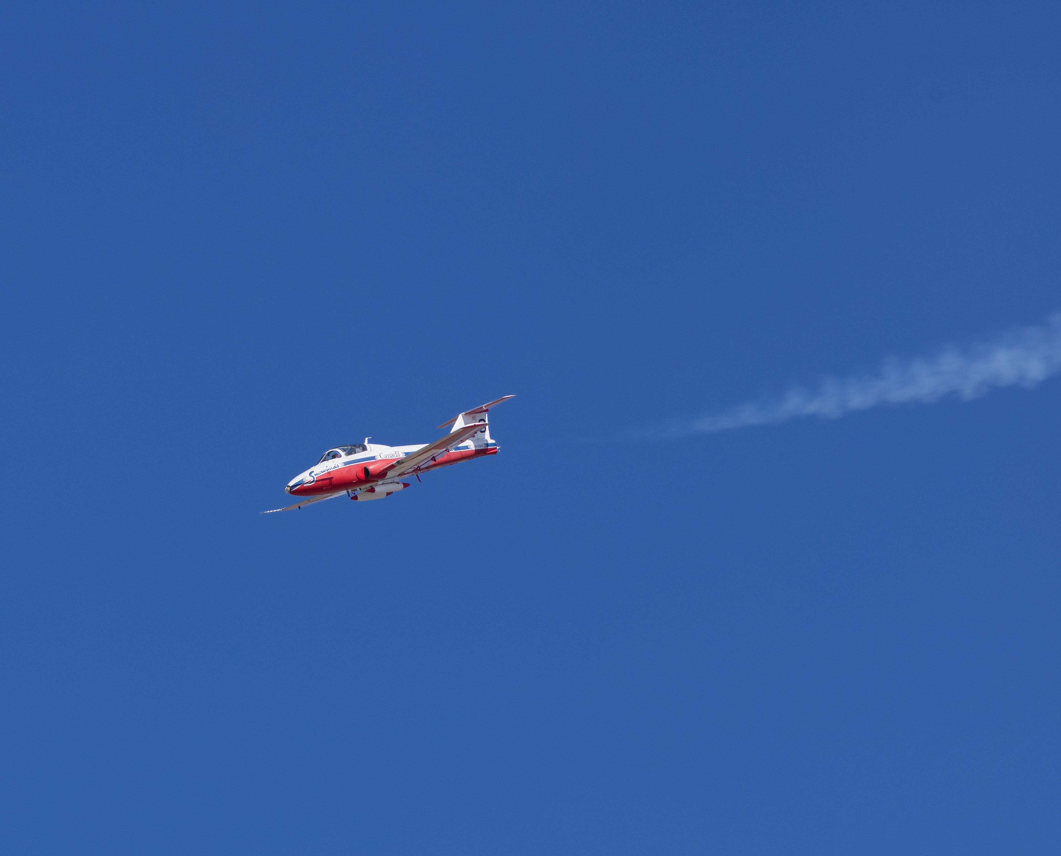 Jet Airplane Flying Against Clear Blue Sky · Free Stock Photo