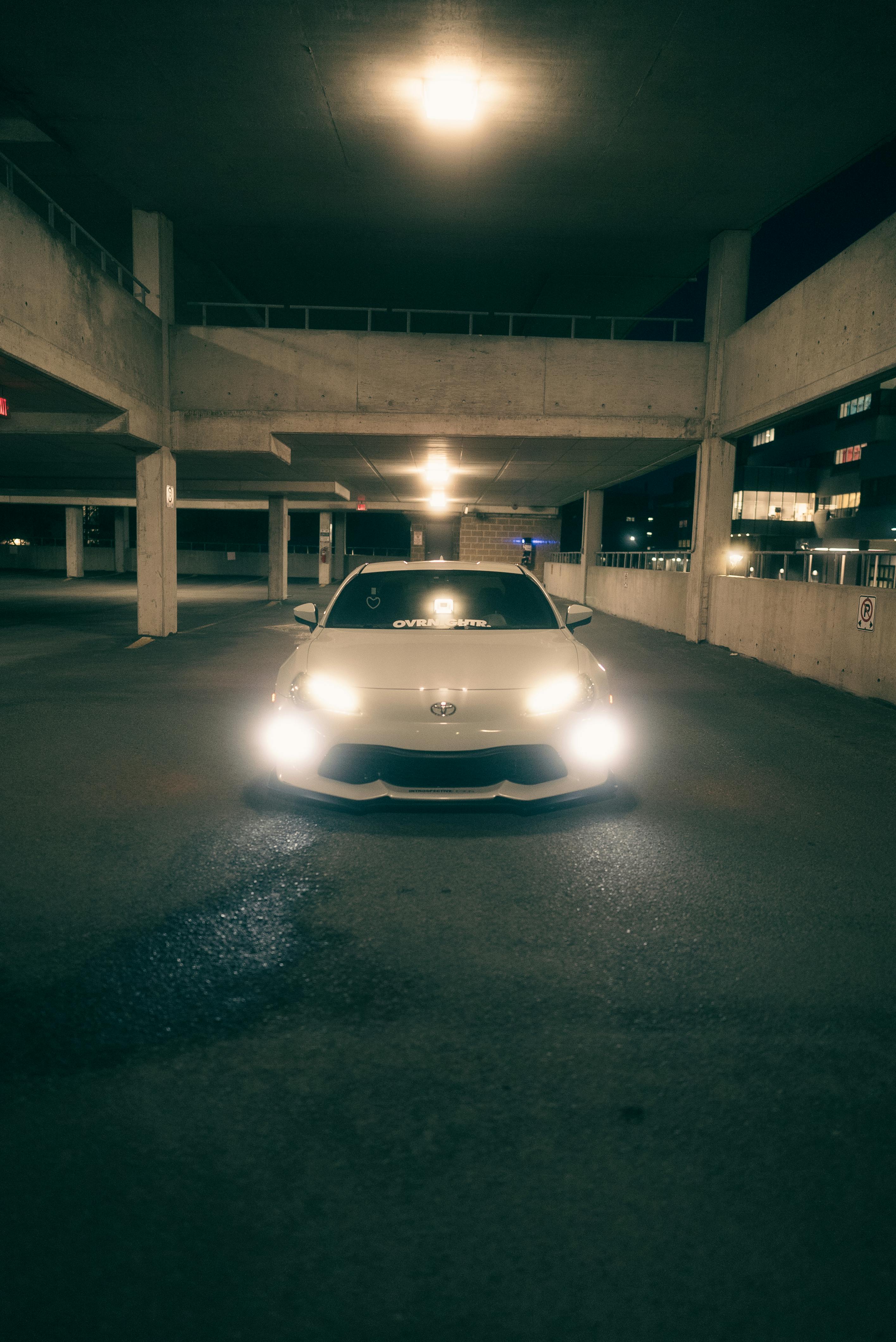 Modern Car in Dimly Lit Parking Garage at Night · Free Stock Photo