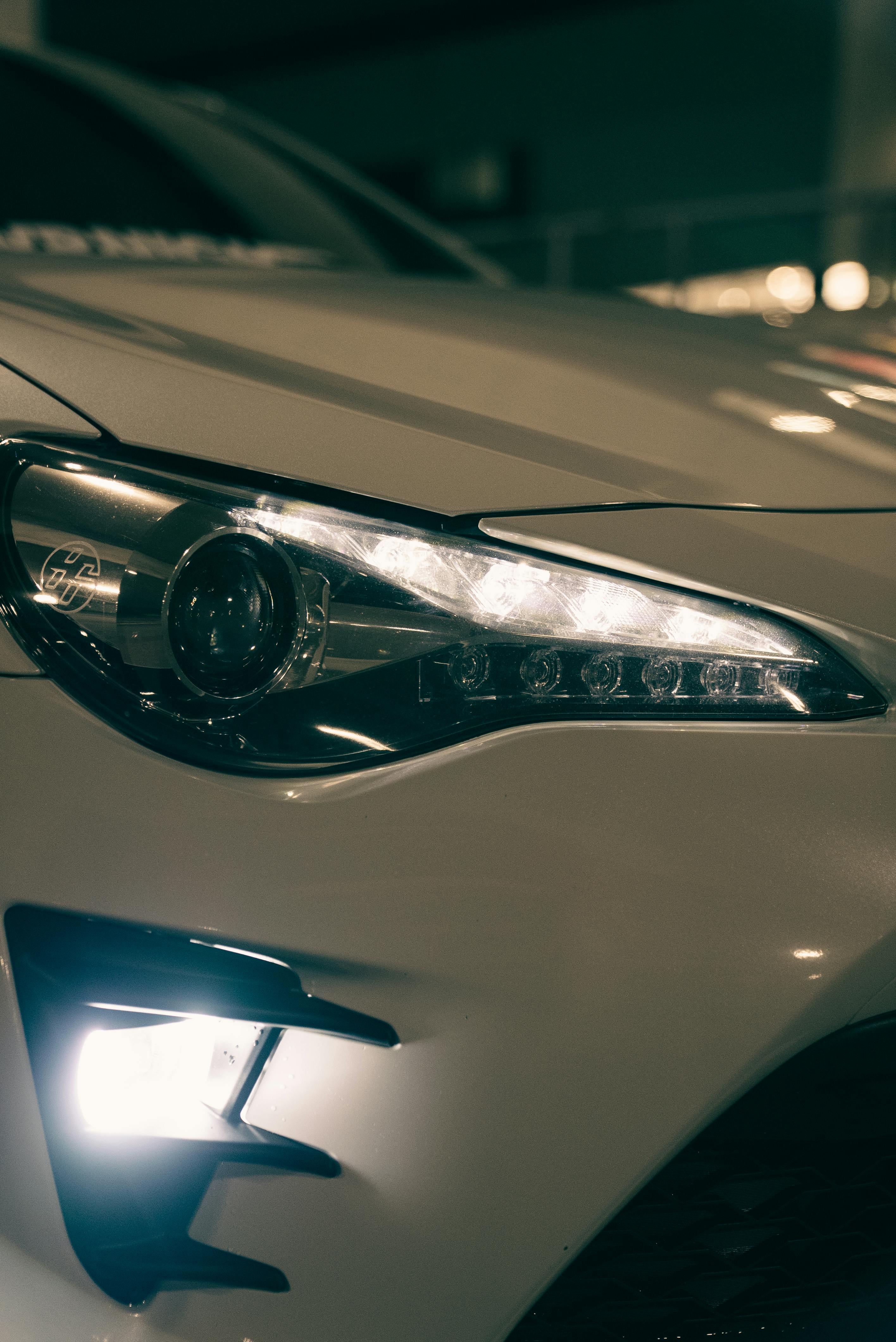 Close-Up of Luxury Sports Car Headlight at Night · Free Stock Photo