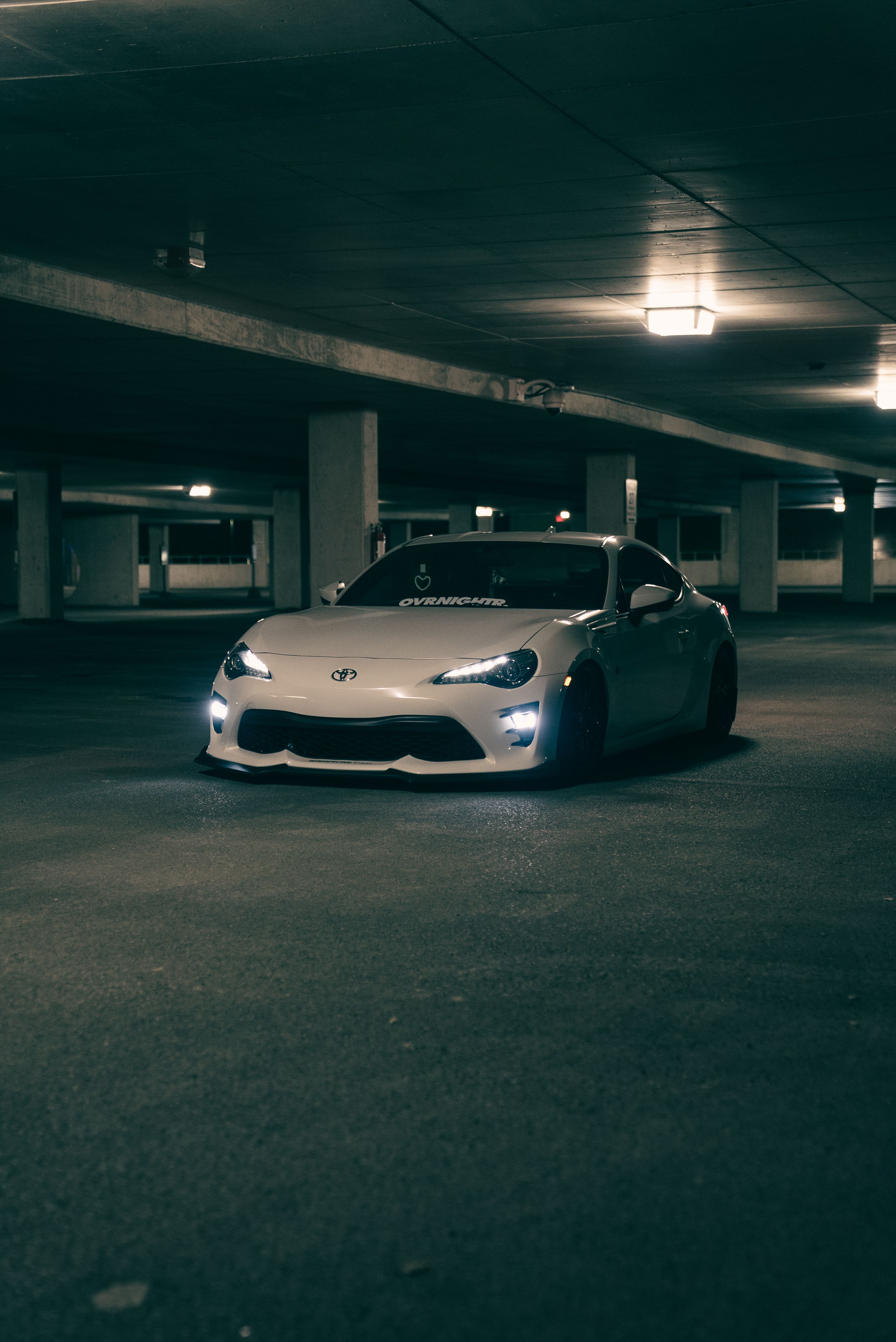 Sleek Sports Car in Dim Parking Garage Setting · Free Stock Photo
