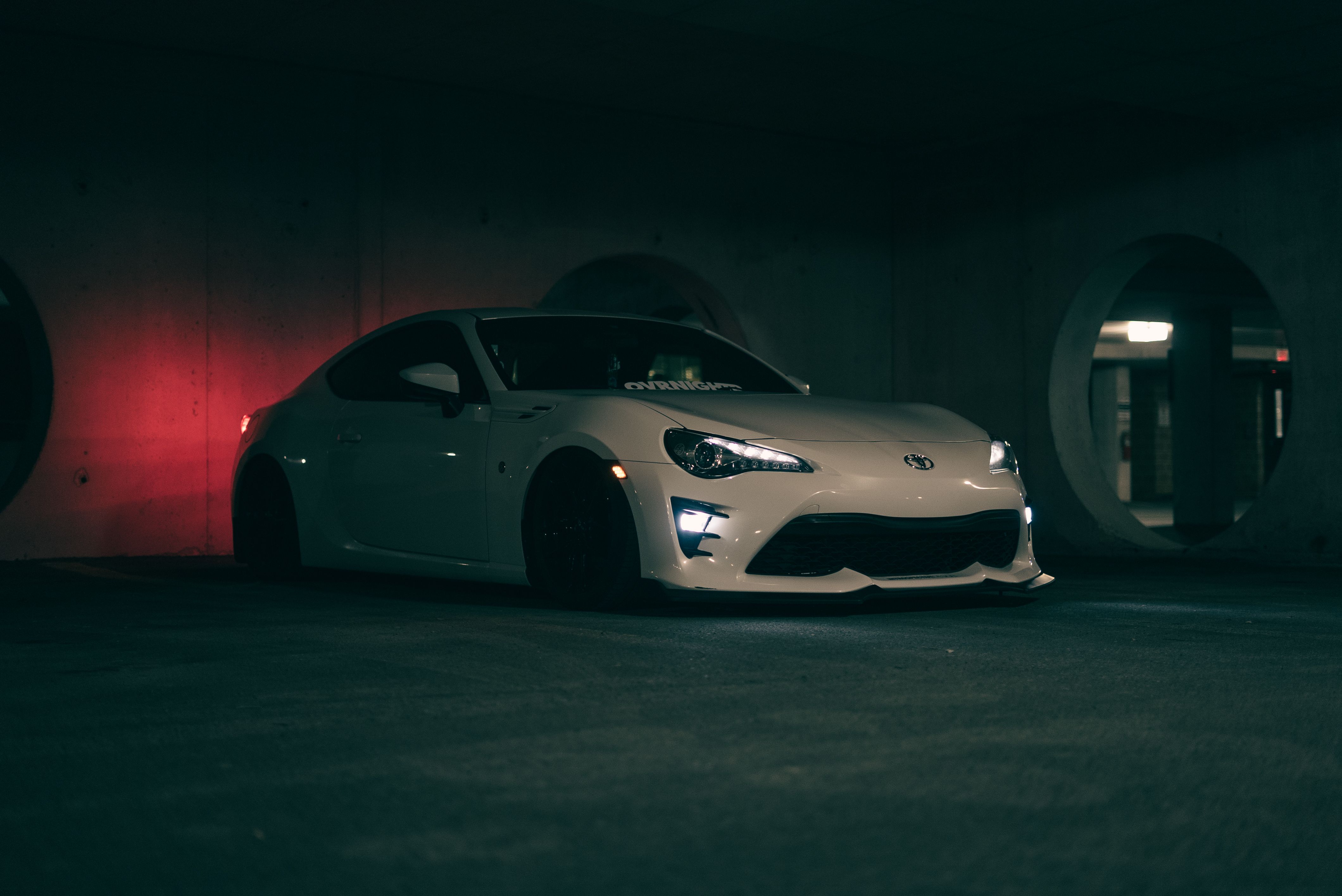 Sleek Sports Car in Dimly Lit Urban Garage · Free Stock Photo