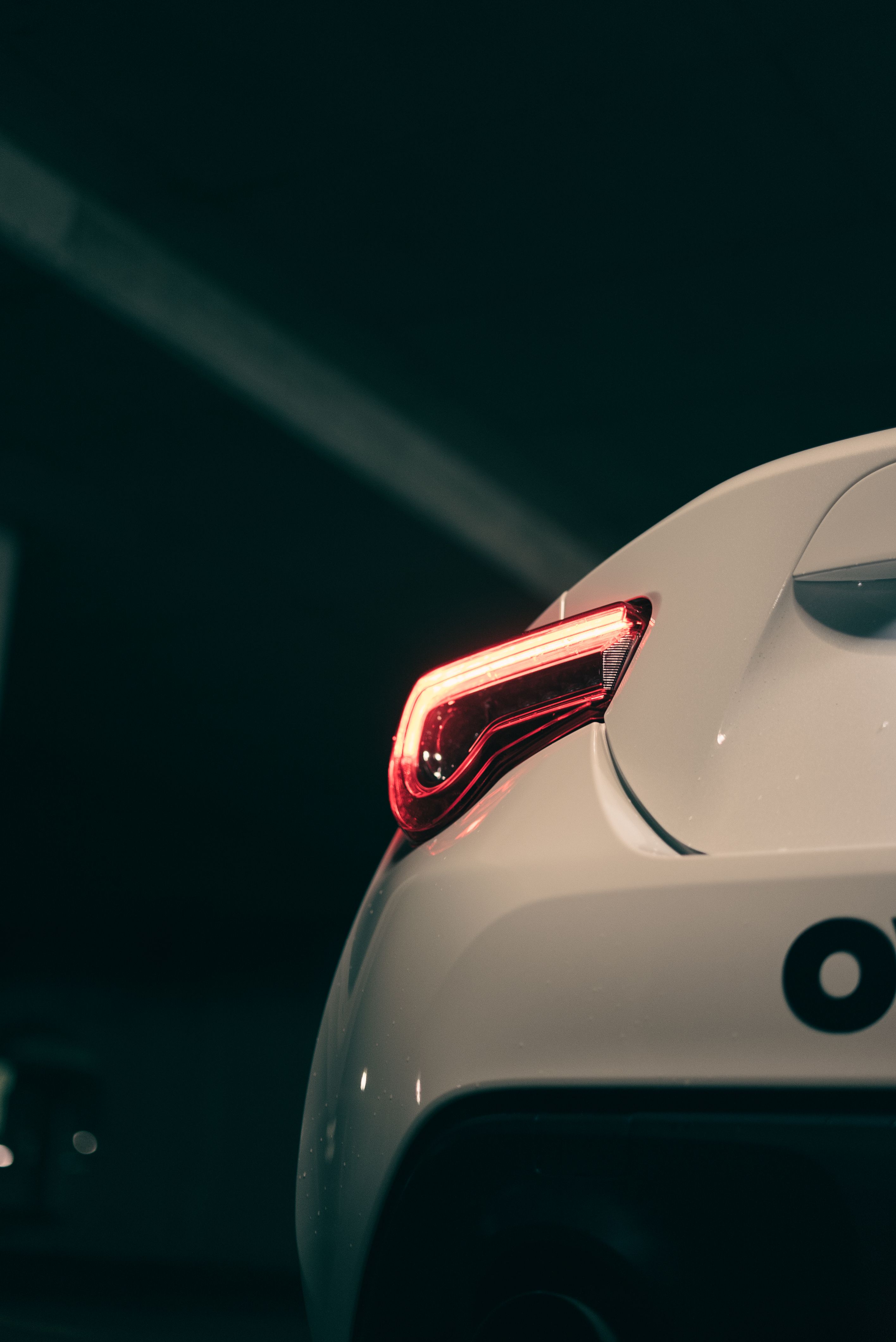 Close-Up of a Modern Car's Tail Light at Night · Free Stock Photo