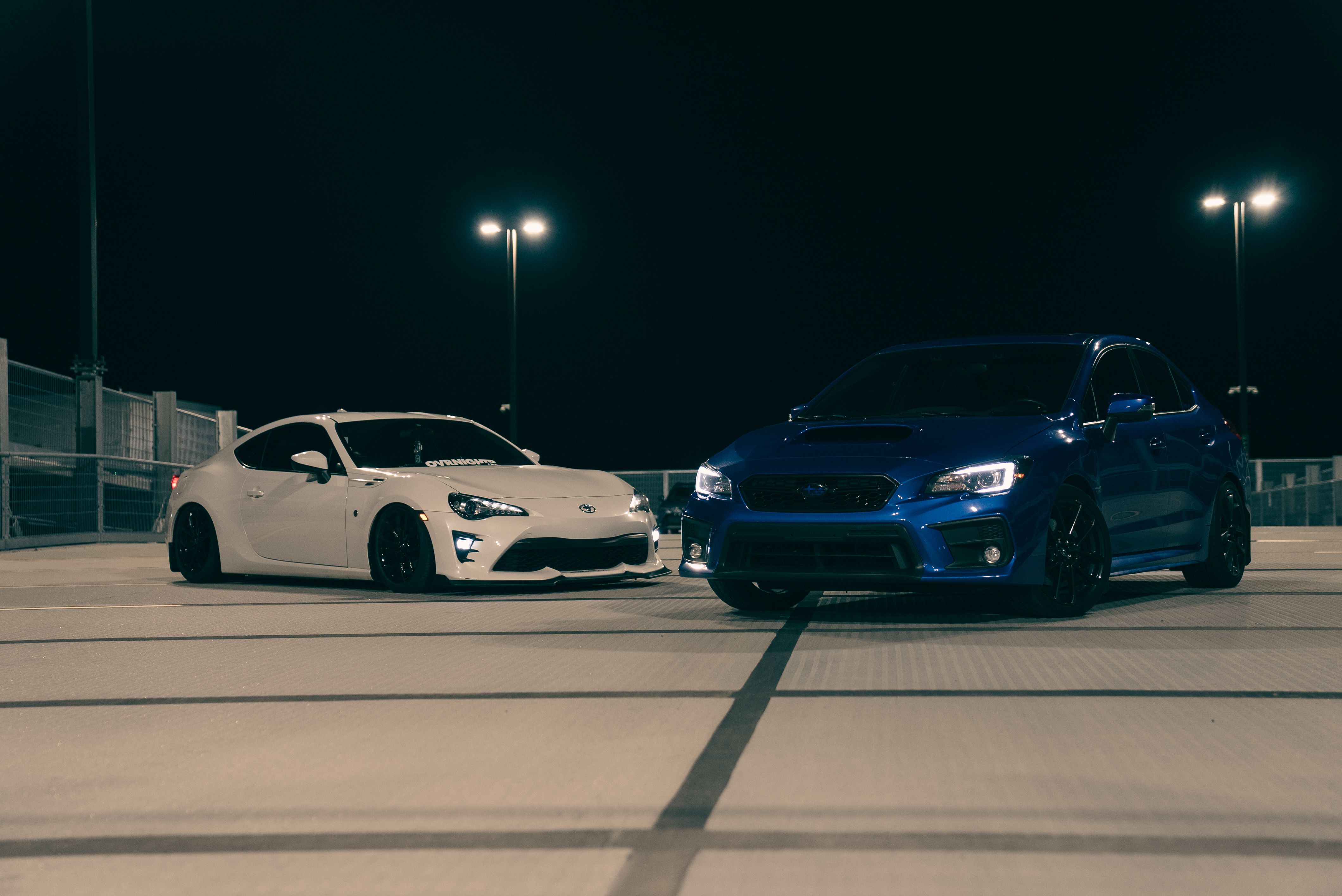 White and Blue Performance Cars at Night · Free Stock Photo