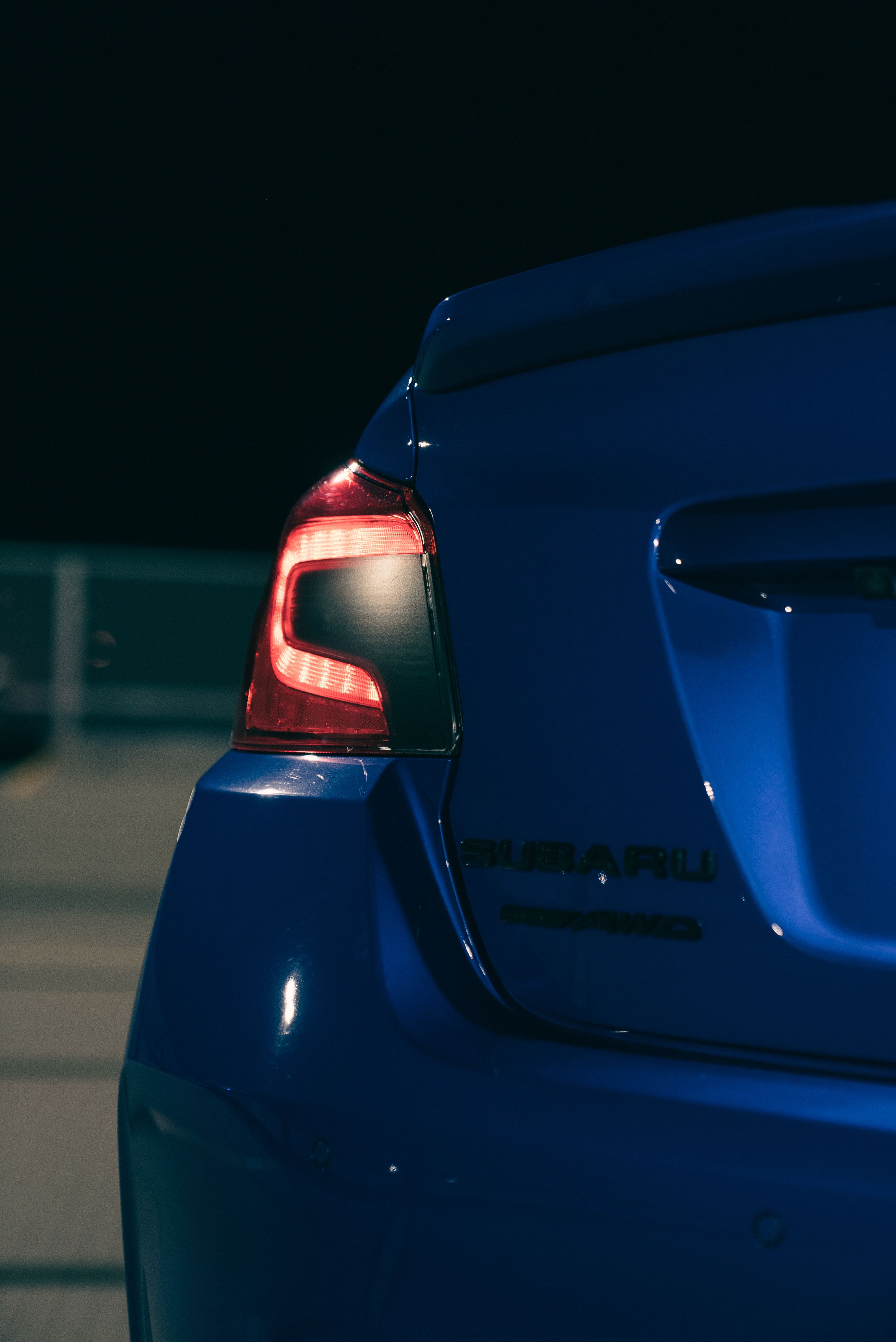 Close-up of a Blue Car's Tail Light at Night · Free Stock Photo