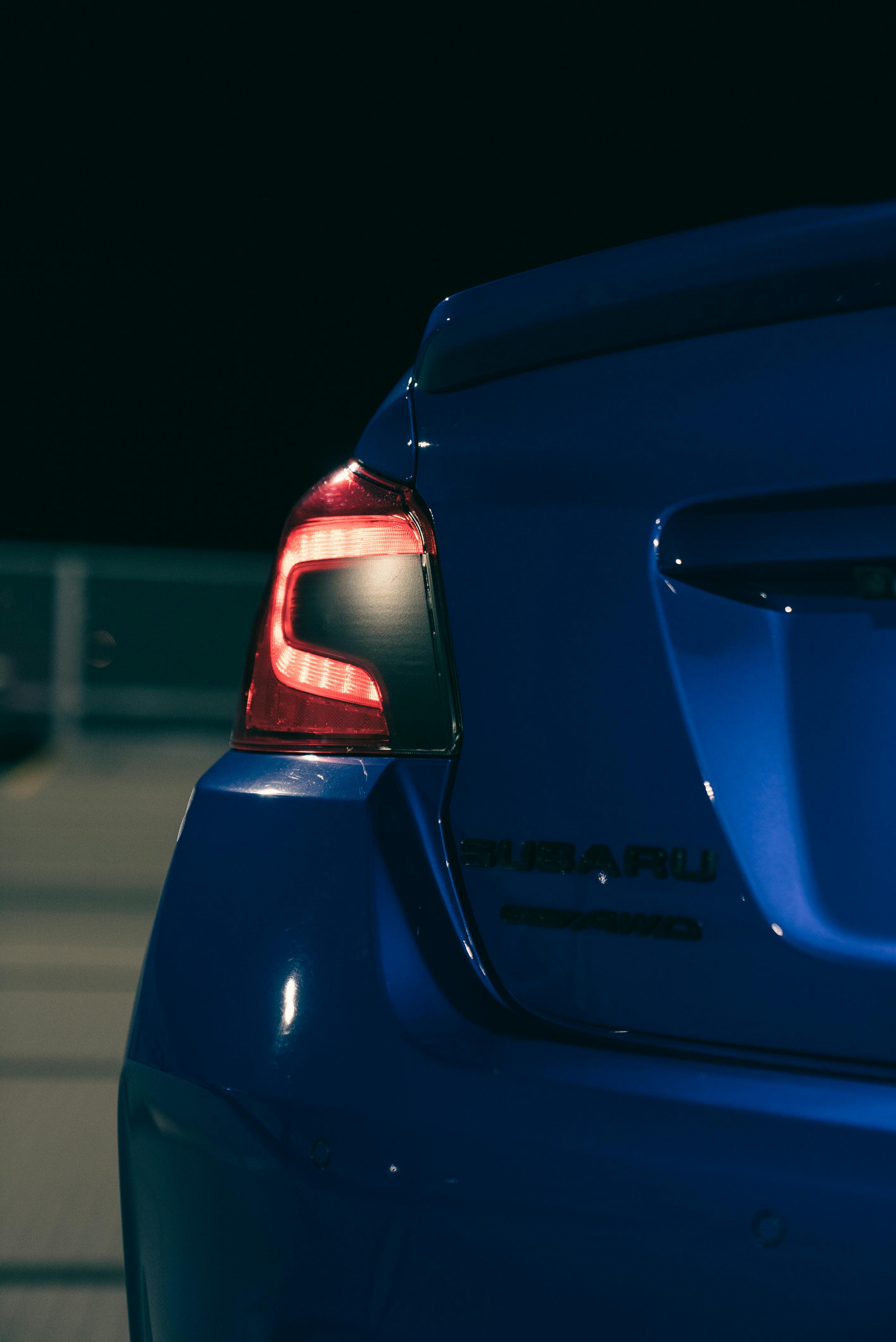 Close-up of a Blue Car's Tail Light at Night · Free Stock Photo