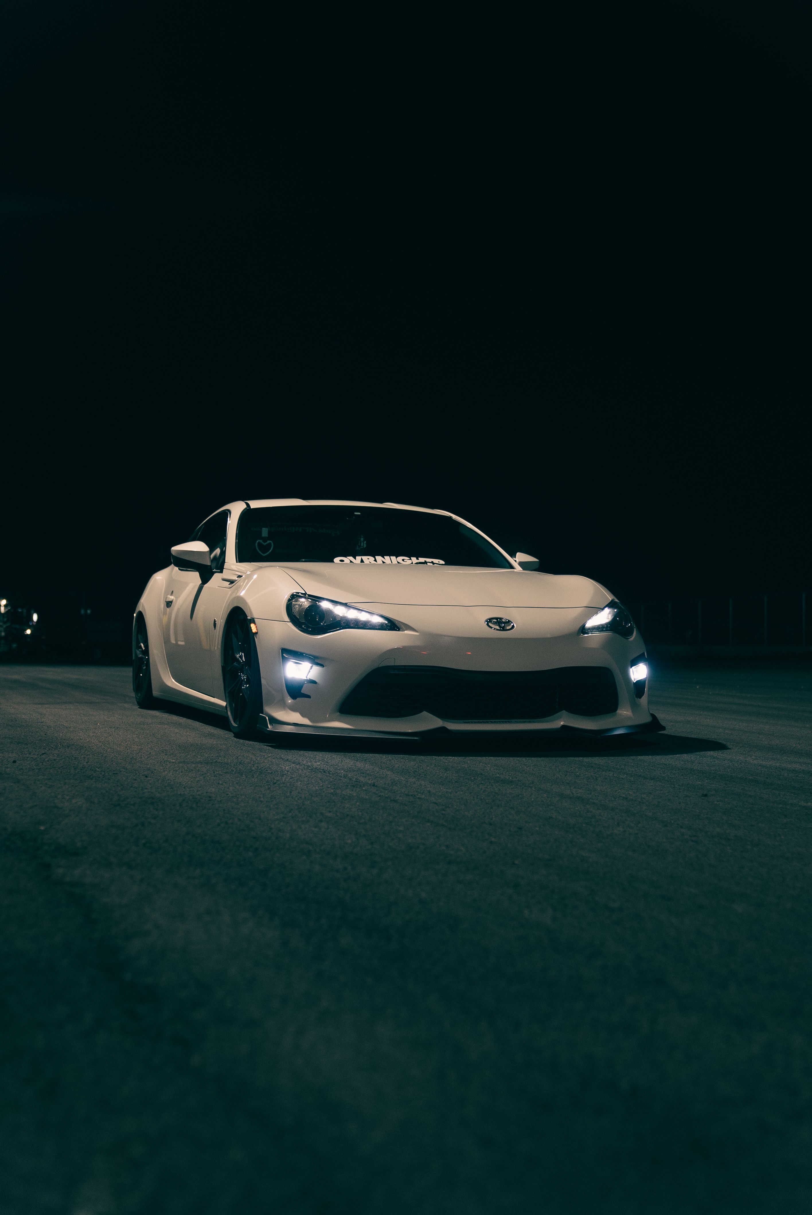 Sleek White Car at Night on Empty Road · Free Stock Photo