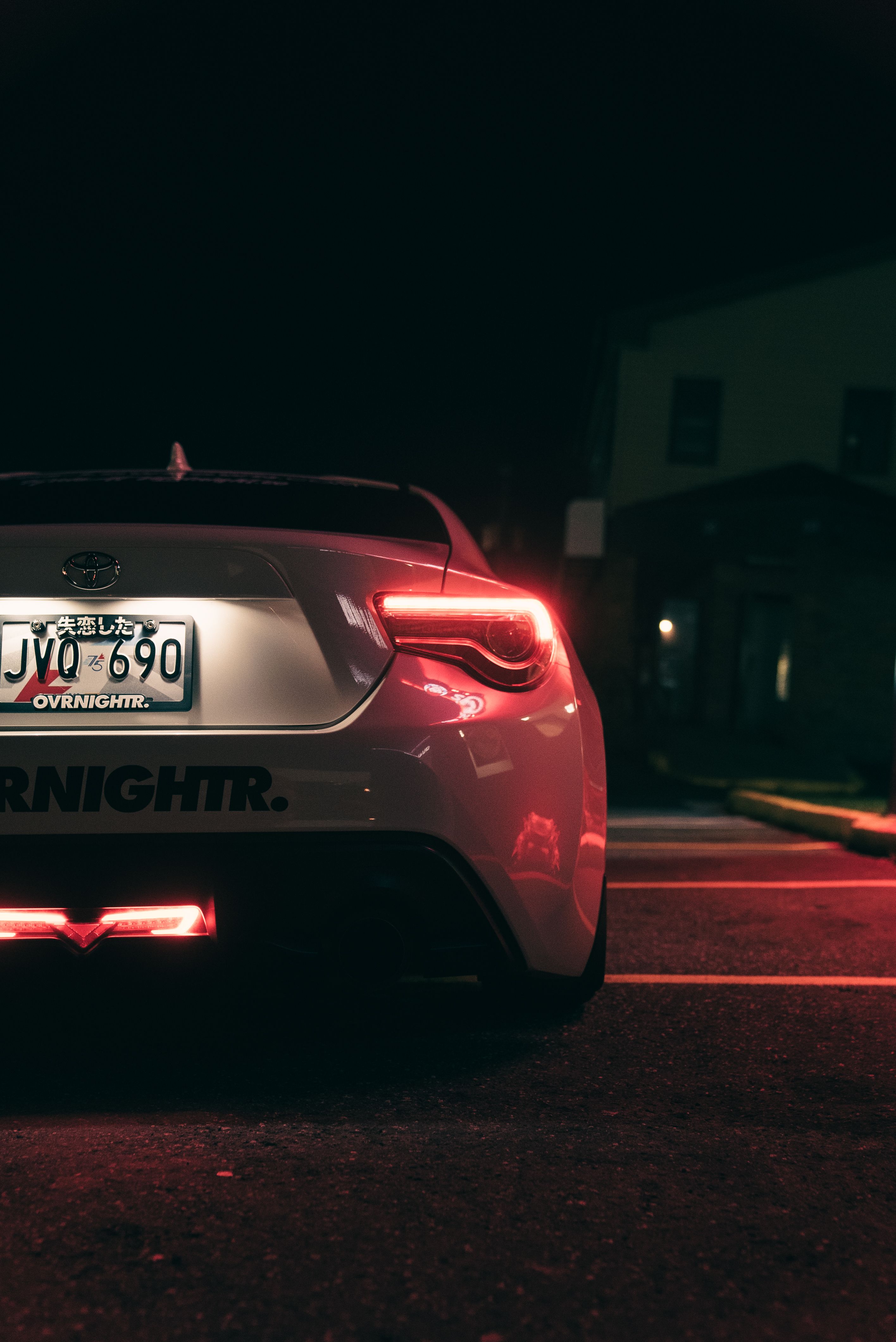 Rear View of a Stylish Car at Night · Free Stock Photo