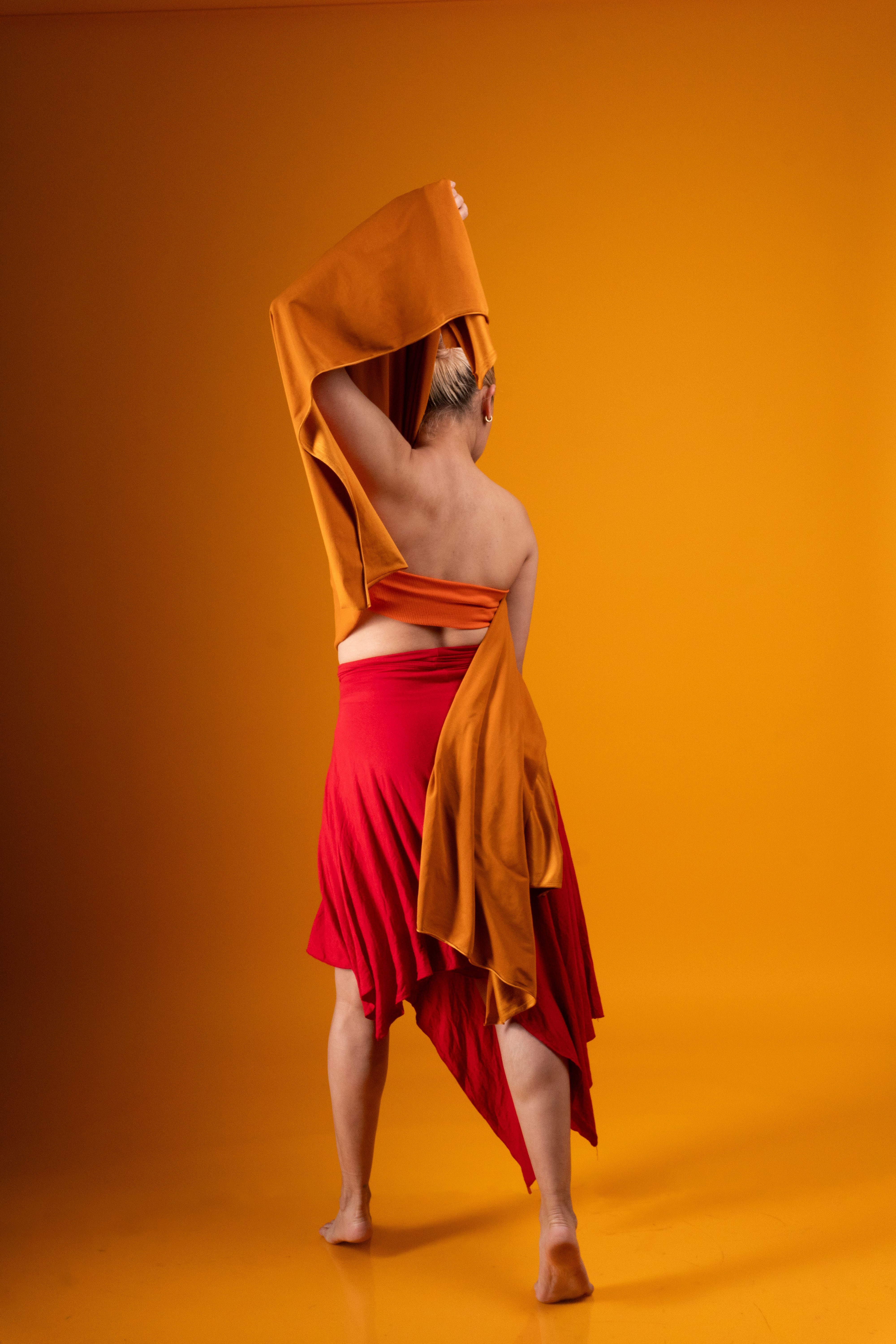 Elegant Dancer in Motion with Orange Backdrop · Free Stock Photo