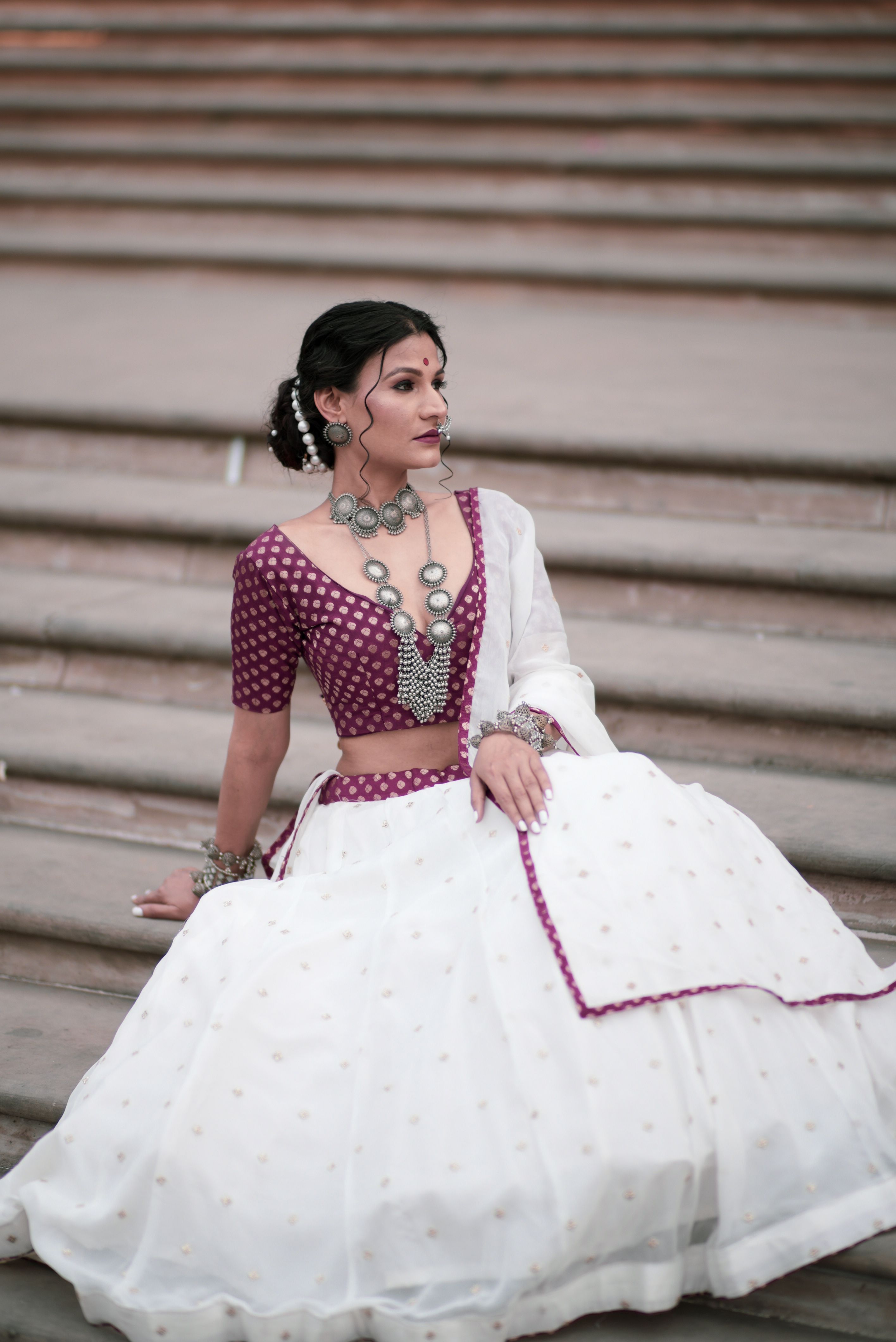 Elegant woman in traditional Indian attire on steps · Free Stock Photo