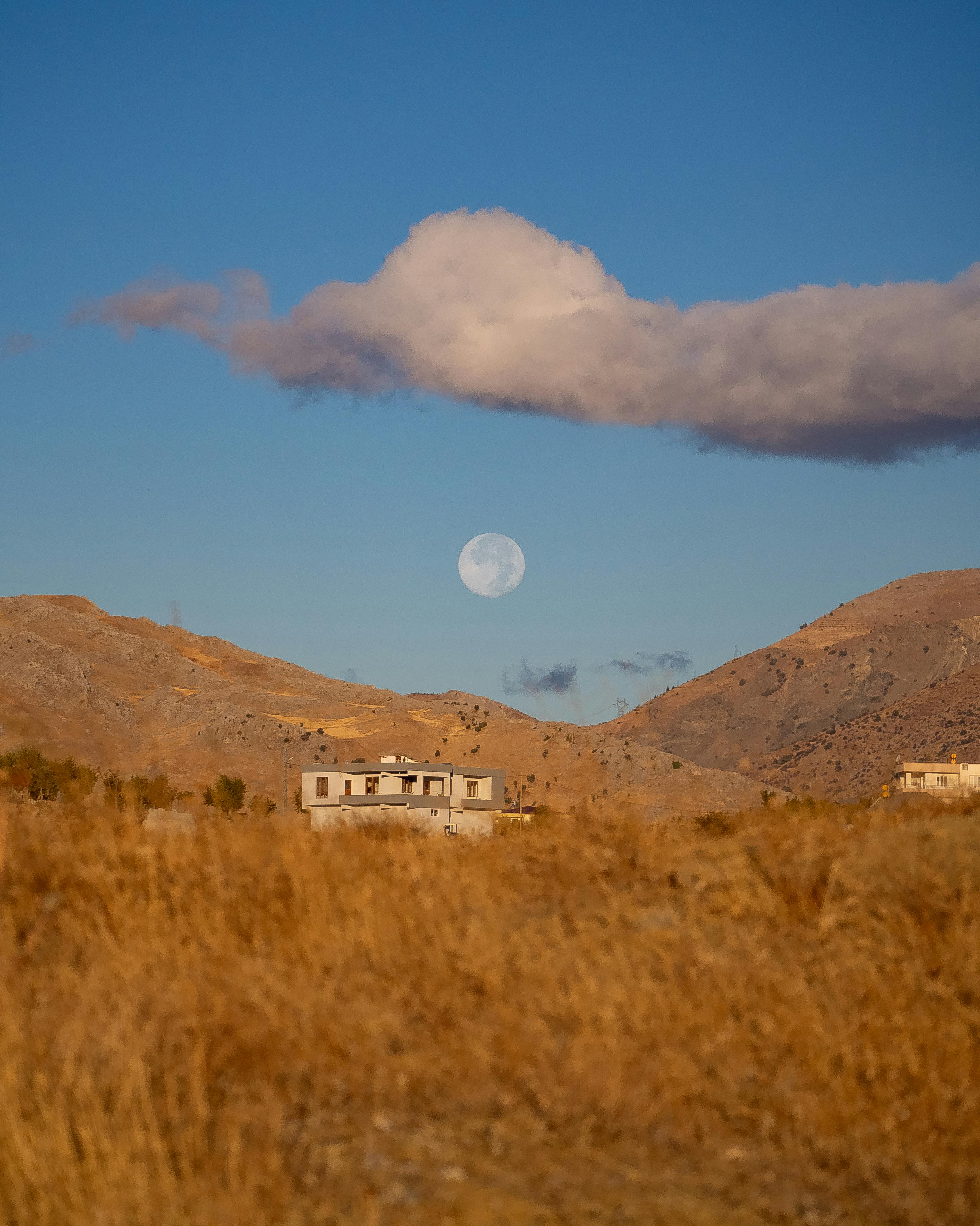 Moonrise Over Desert Landscape with Clouds · Free Stock Photo
