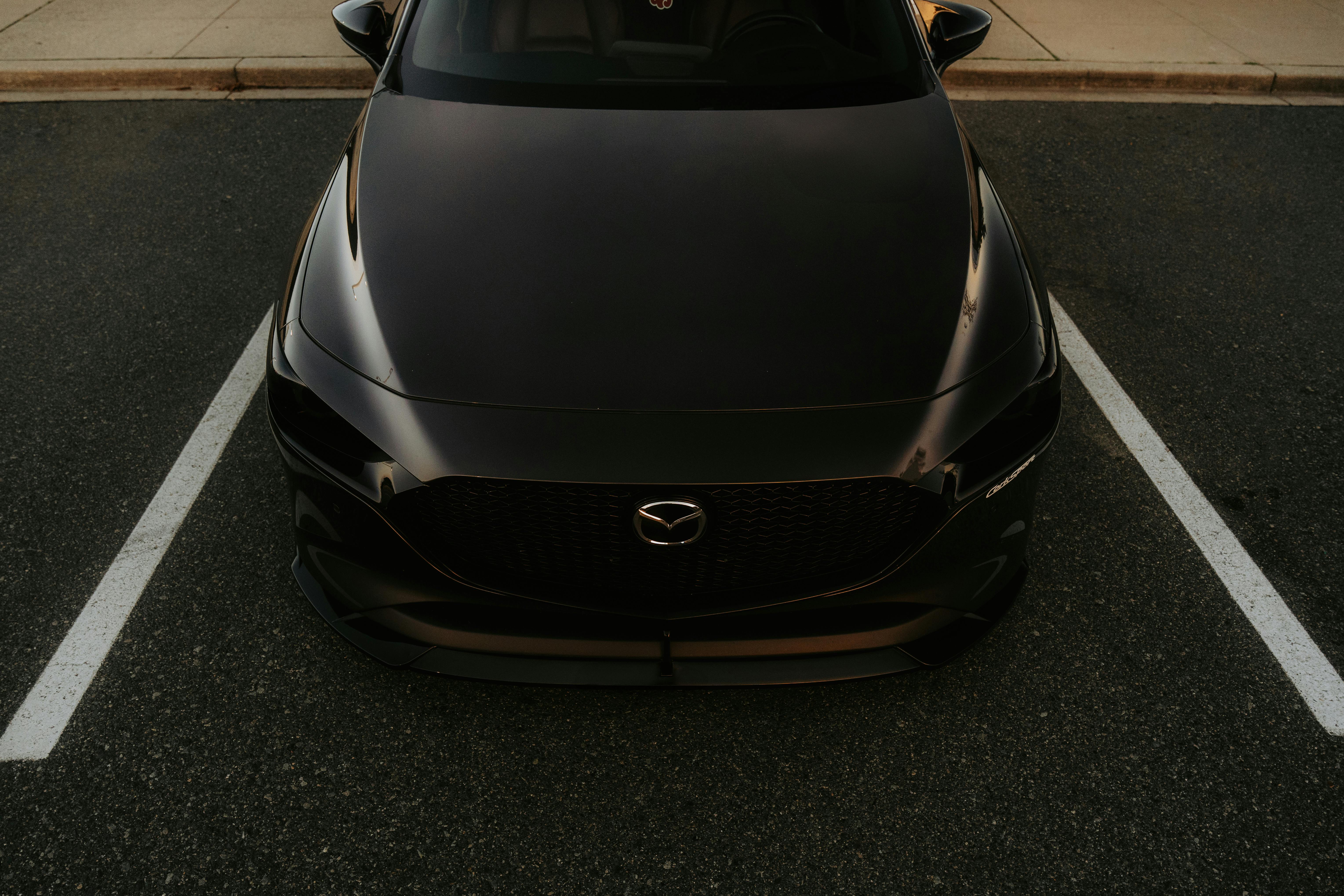 Top View of a Black Car in Parking Space · Free Stock Photo