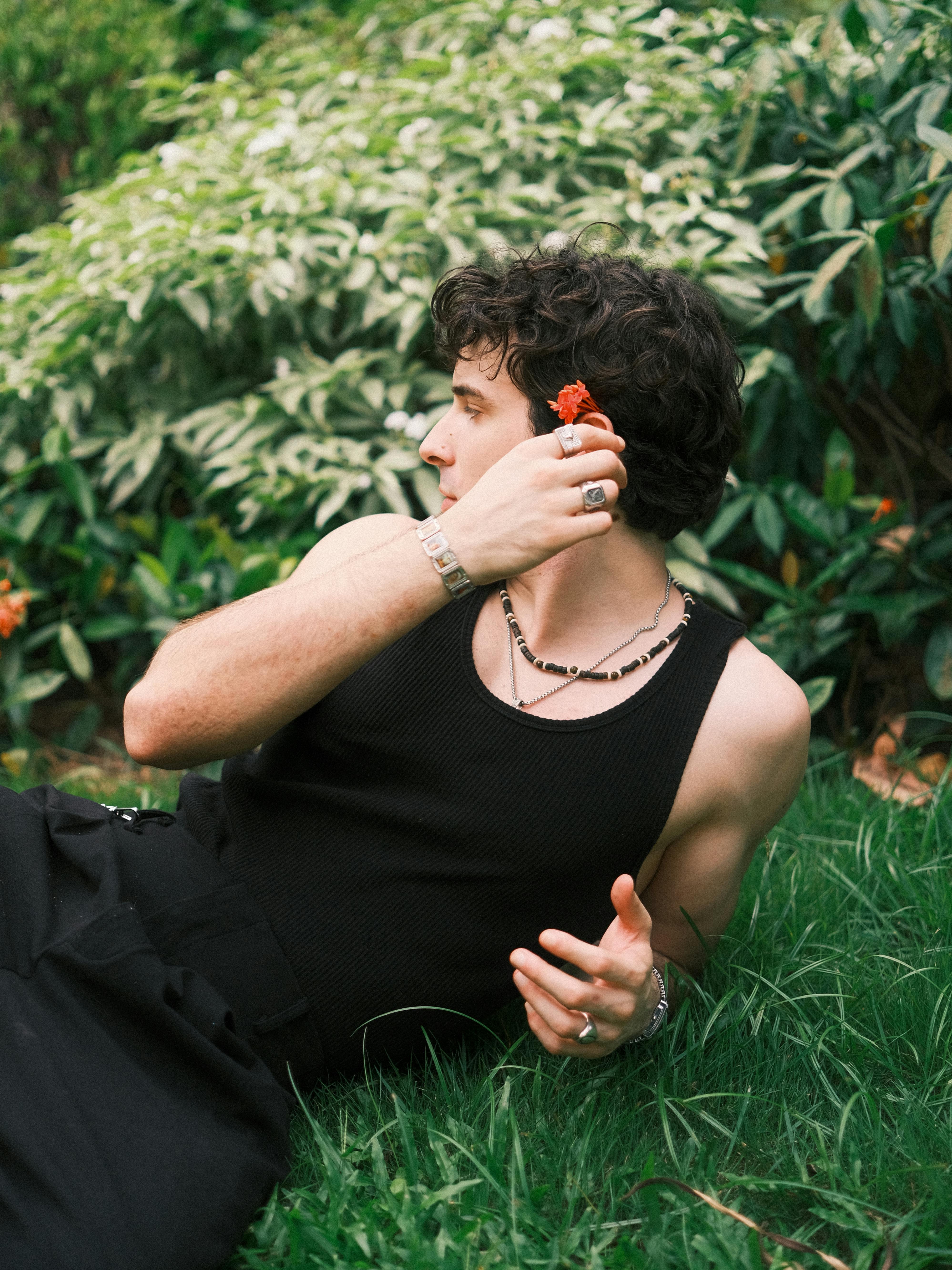 Man Relaxing in Garden with Red Flower · Free Stock Photo