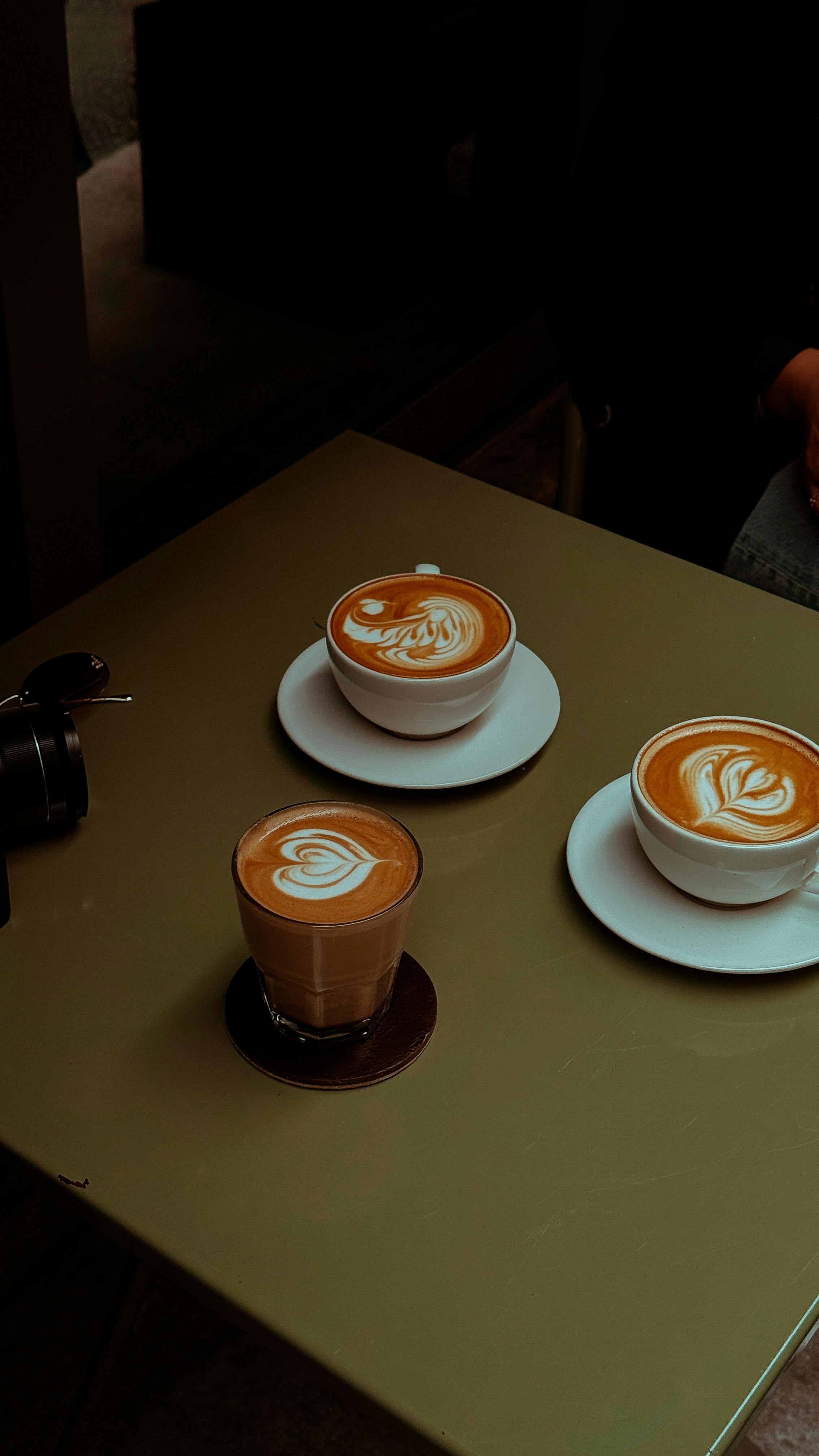 Artistic Latte and Cappuccino Coffee Art on Table · Free Stock Photo