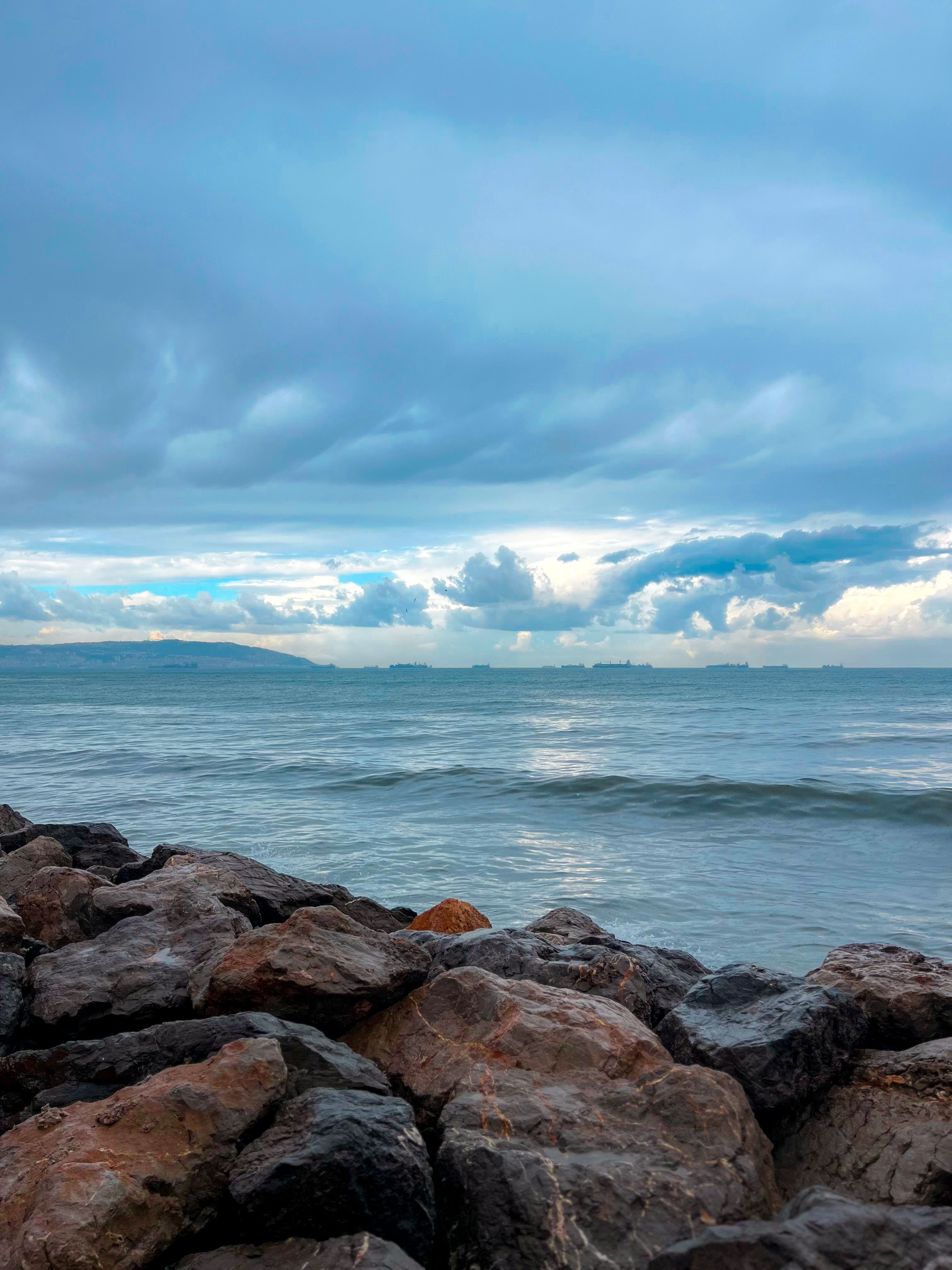 Scenic Ocean View with Dramatic Clouds and Rocks · Free Stock Photo